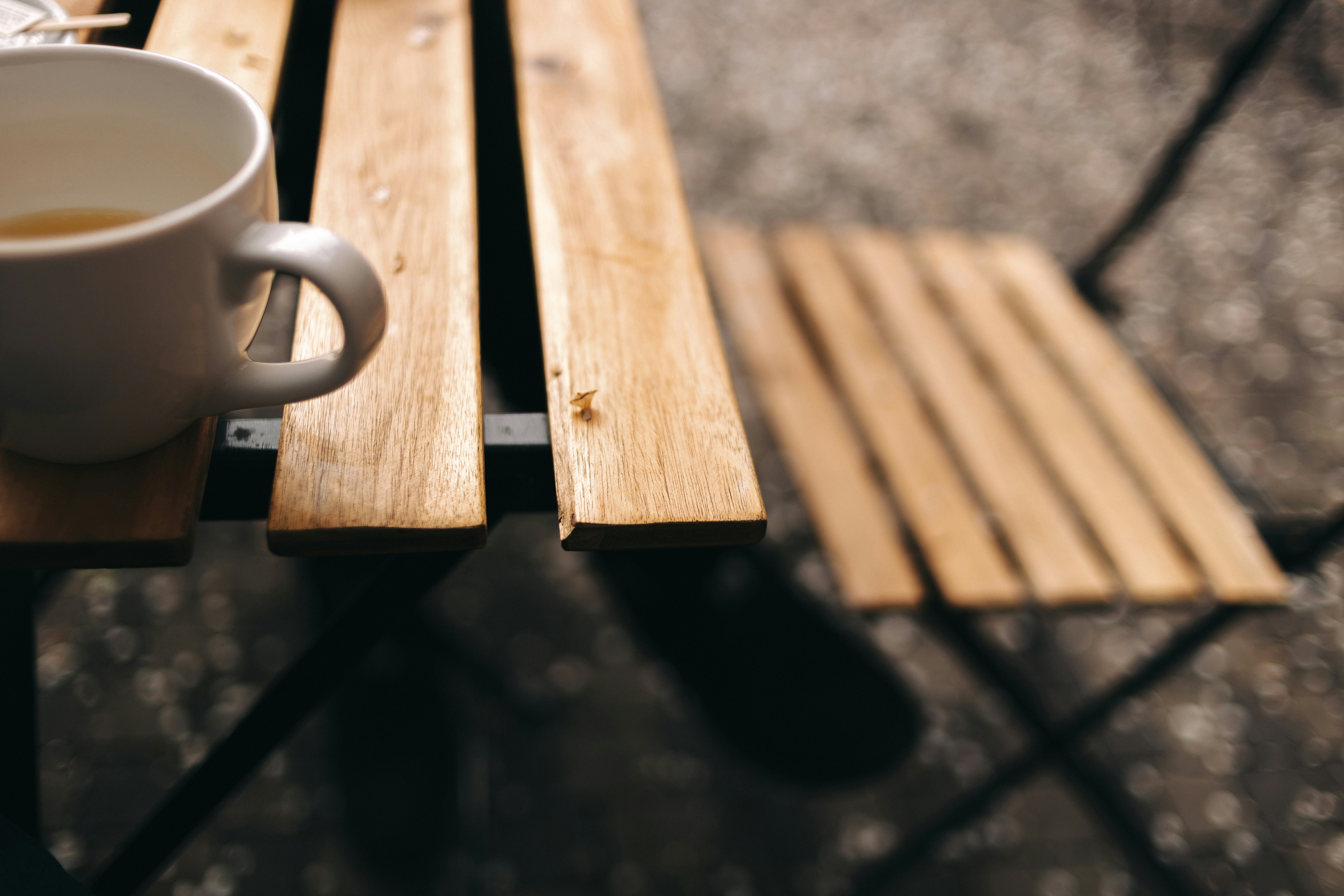 white ceramic mug on brown wooden table