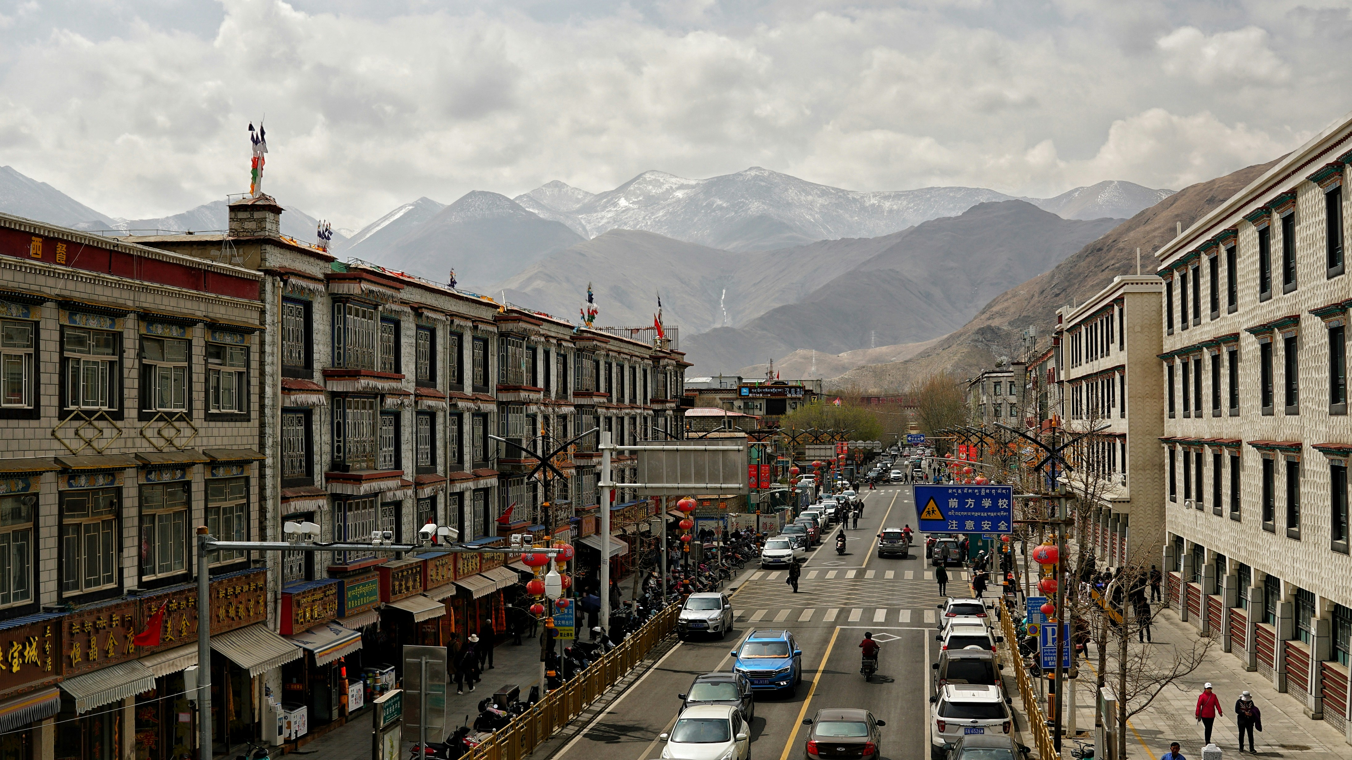 Mountain Town Street Corridor with Snow-Capped Peaks