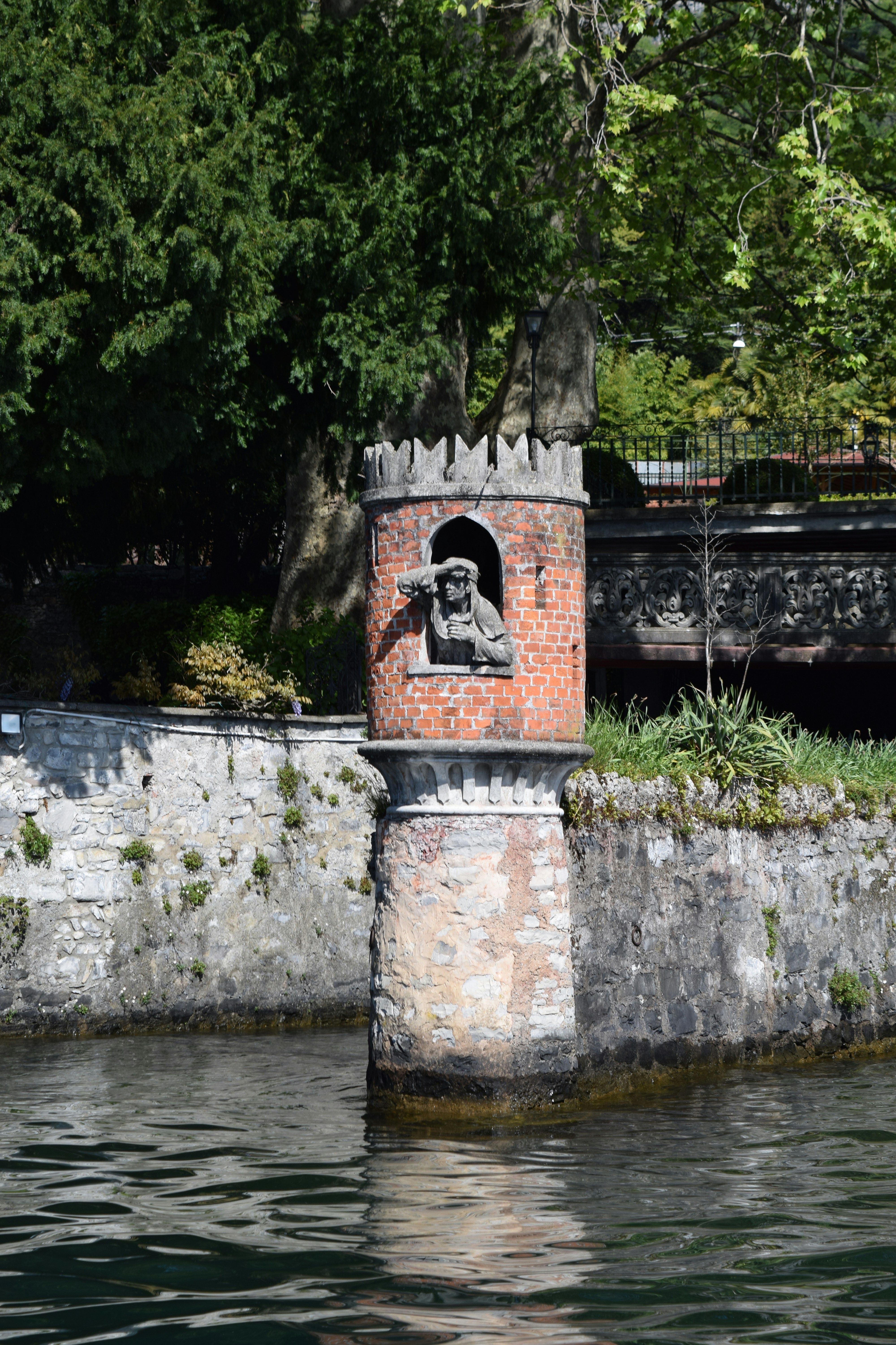 Brick Turret Sentinel: A Carved Figure Overlooking the Riverside
