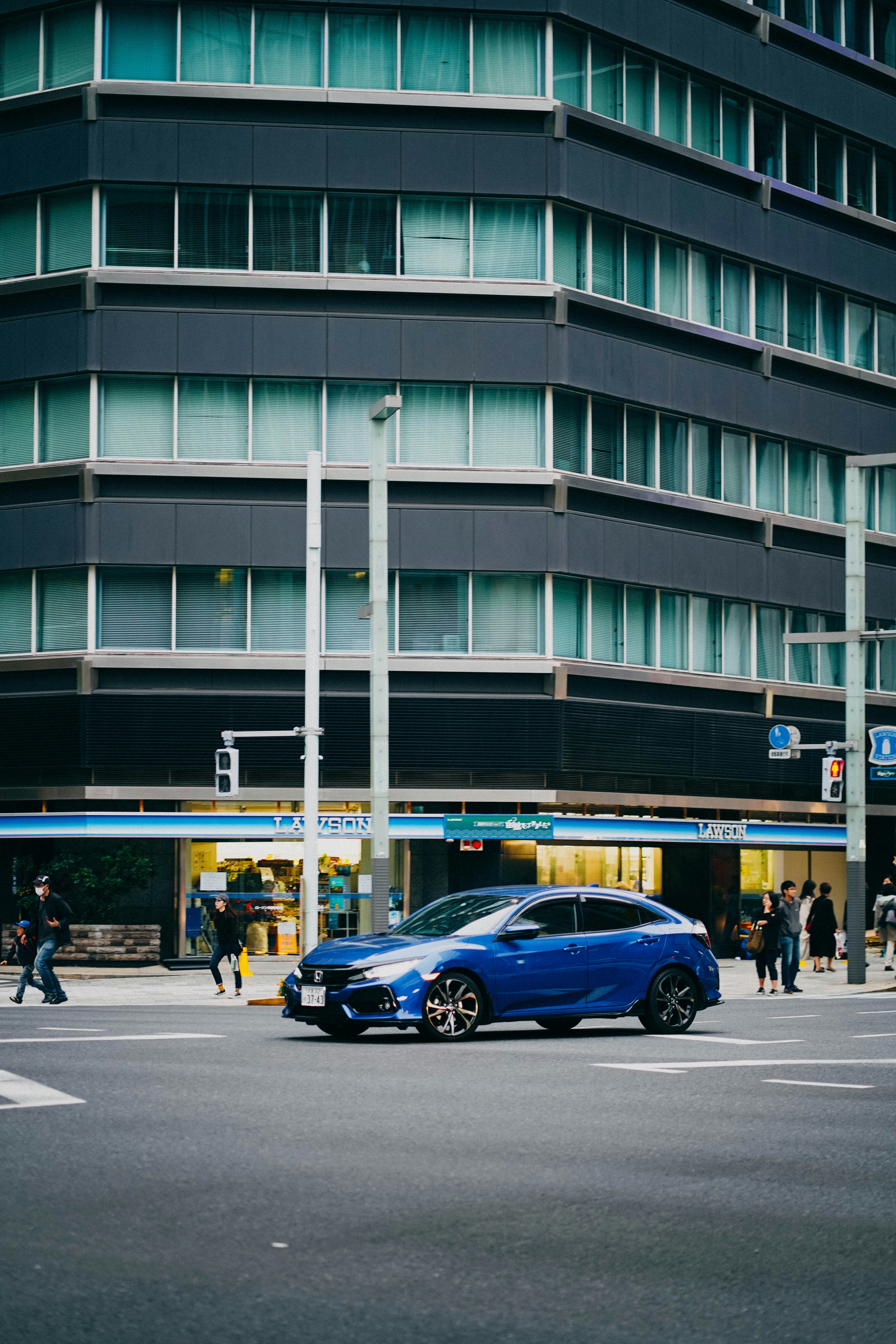 Cobalt Sedan in the Glass Grid: Urban Street Portrait