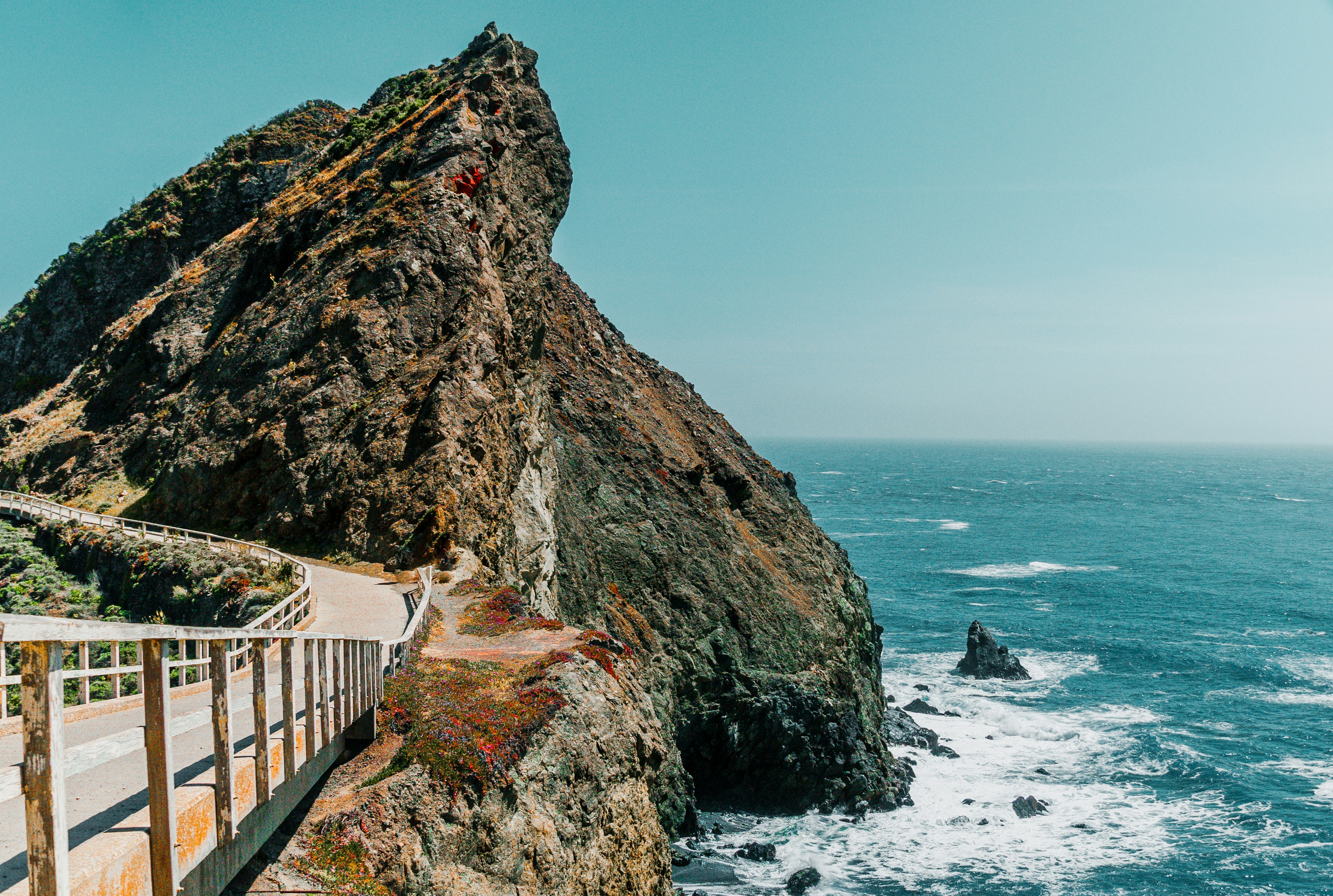 Brown rock formation near body of water during daytime photo – Free ...