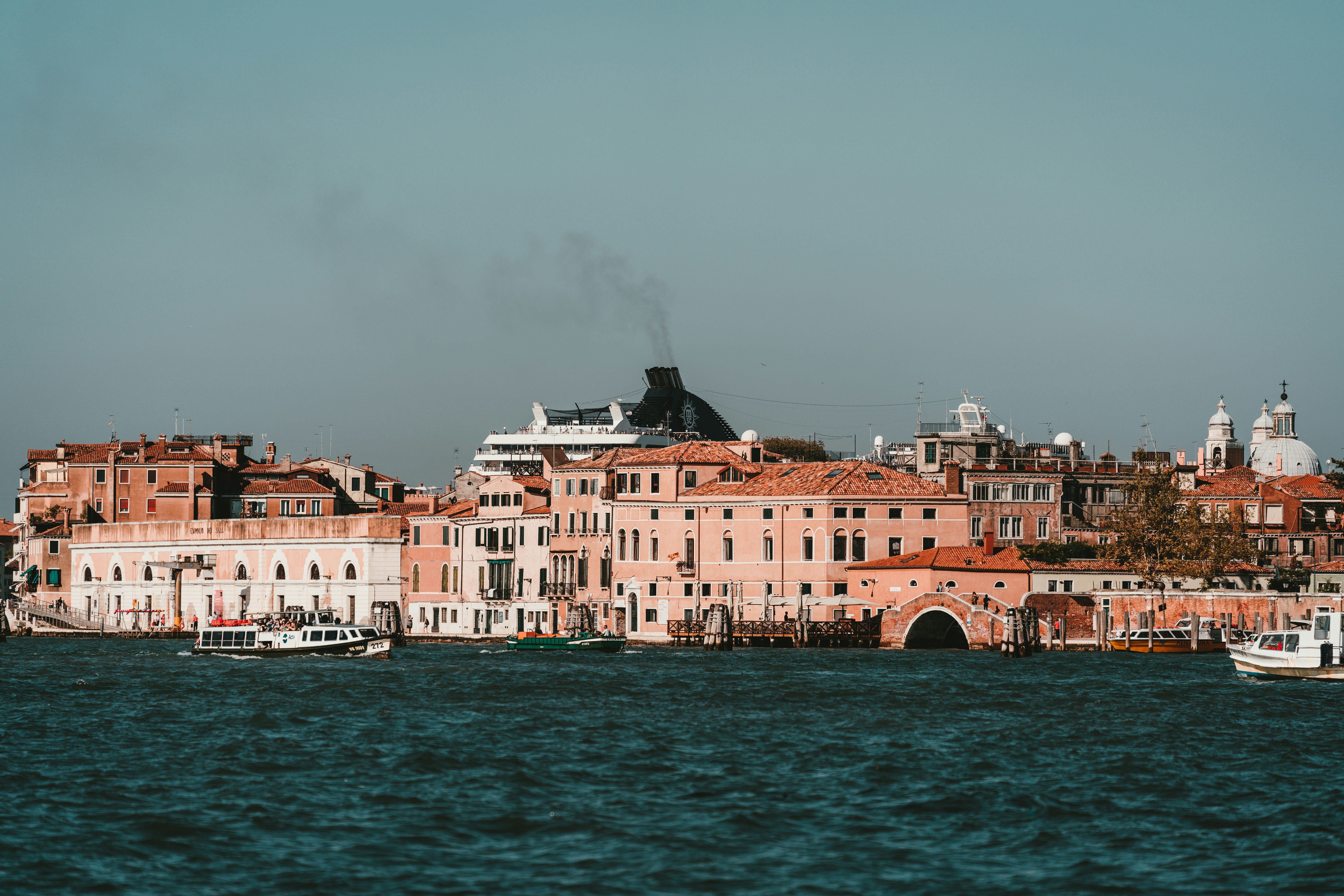 White and brown concrete building beside body of water during daytime ...