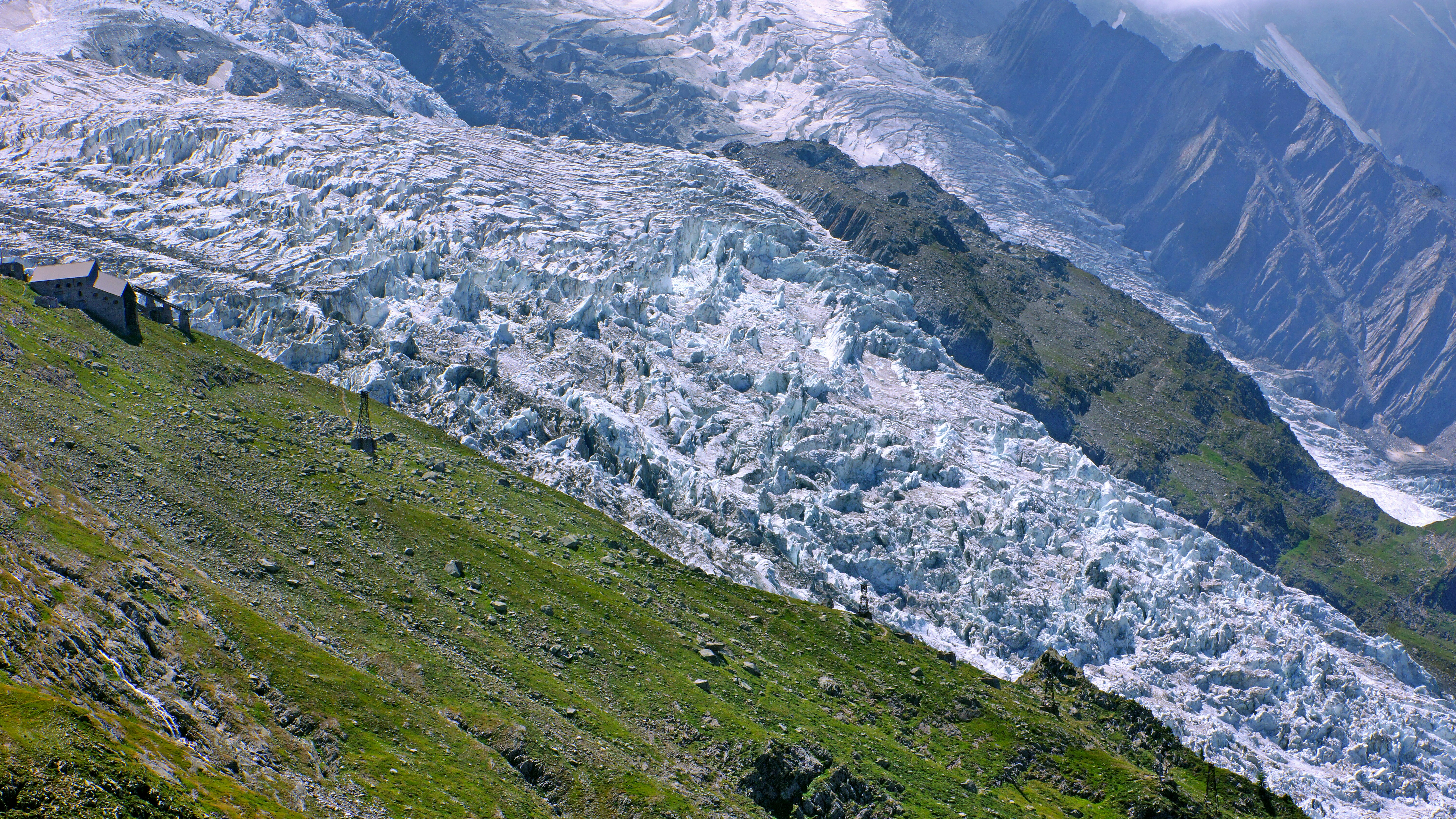 green grass field and snow covered mountain during daytime