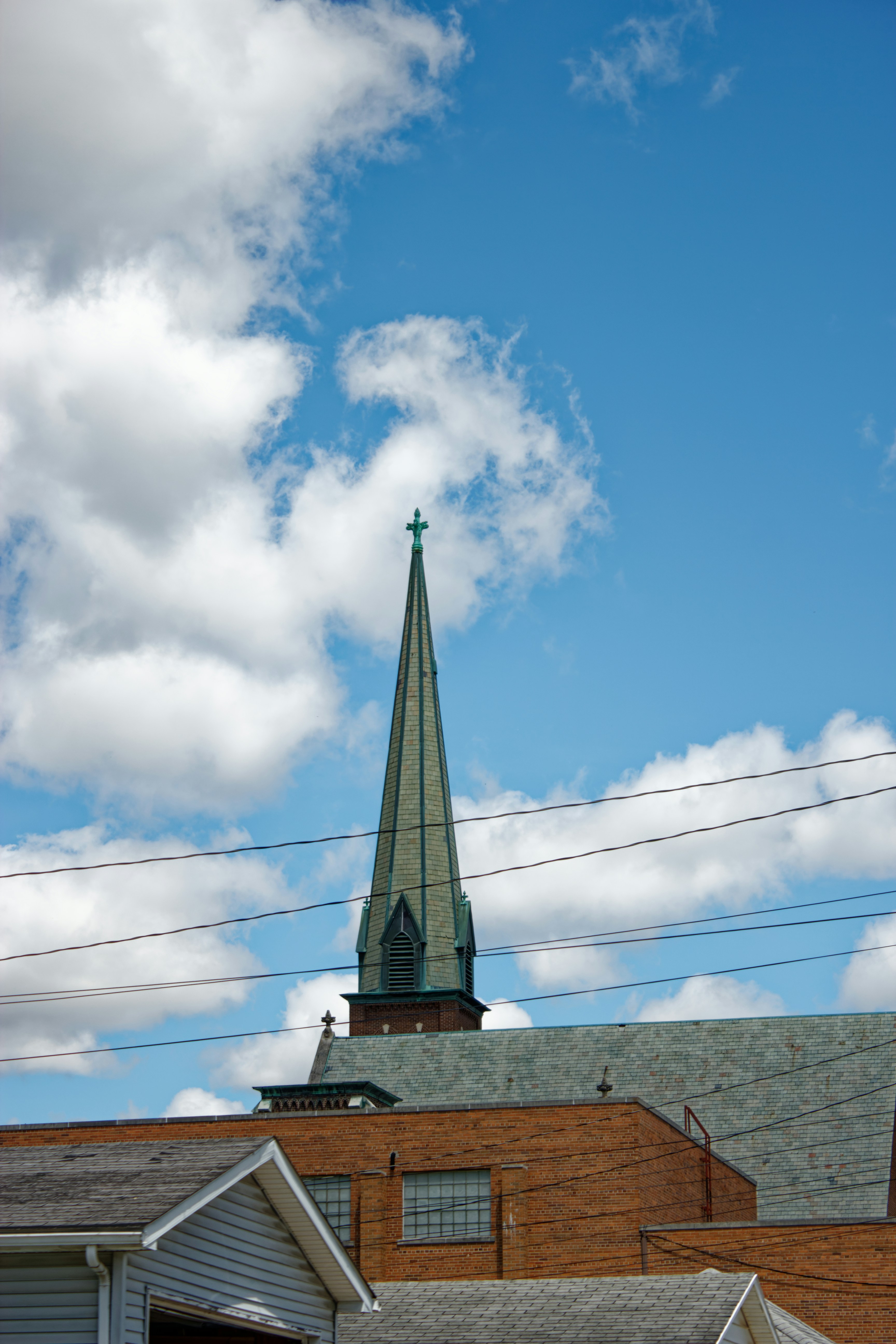 Spire in the Sky: A Quiet Urban Church Against a Cerulean Canvas