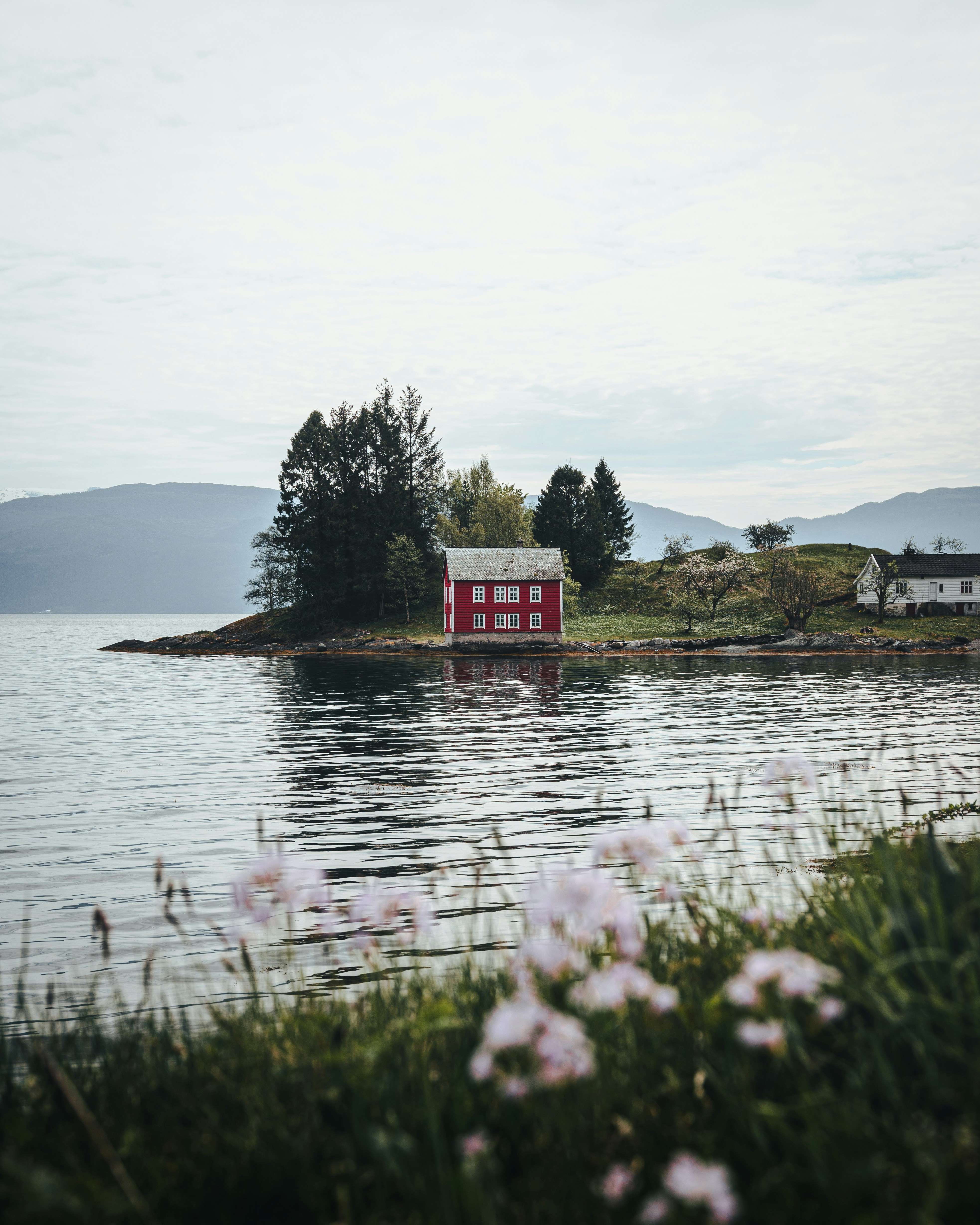 Red and white wooden signage near body of water during daytime photo ...