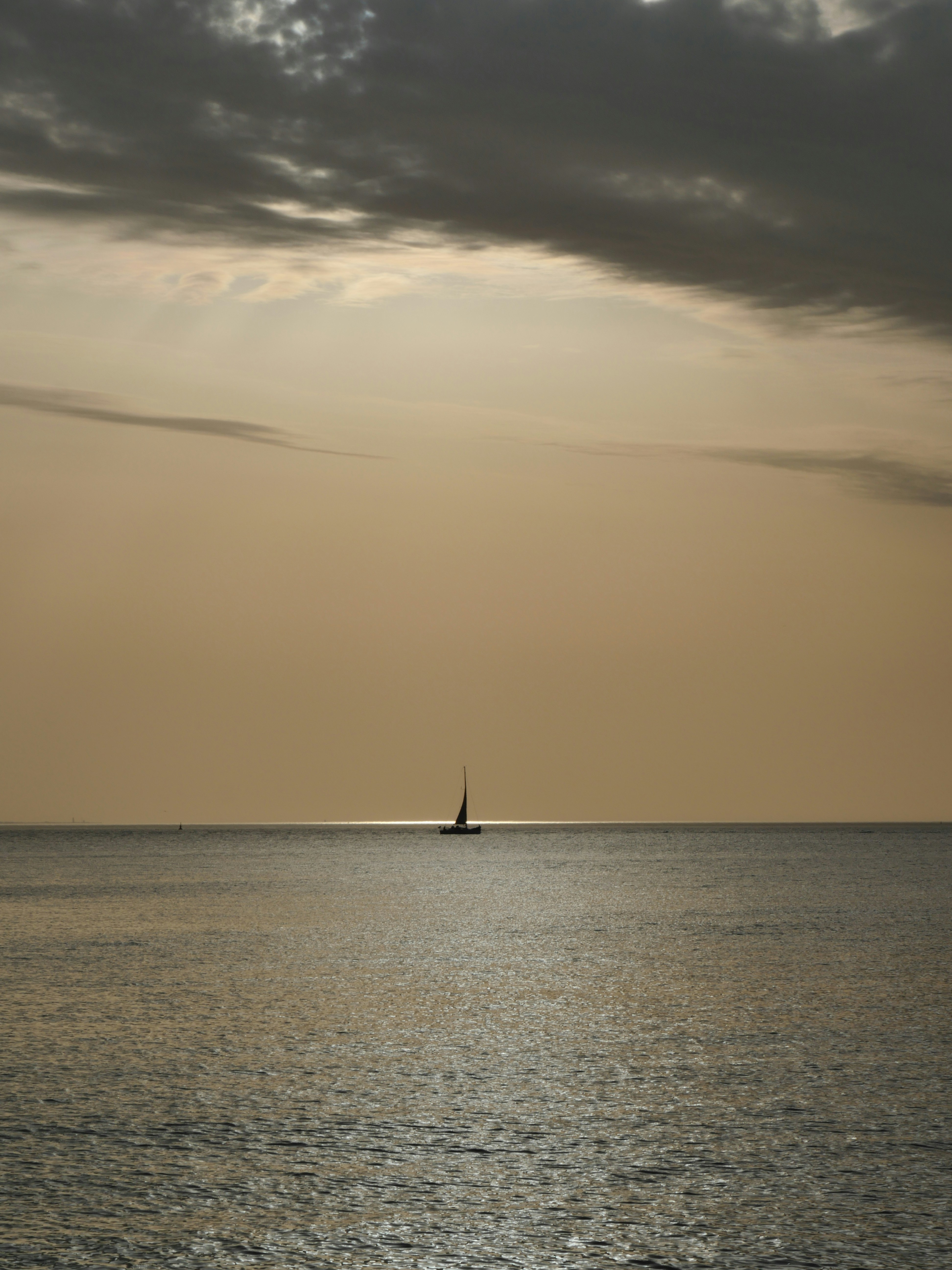 A sailboat in the distance in the ocean photo – Free France Image on ...