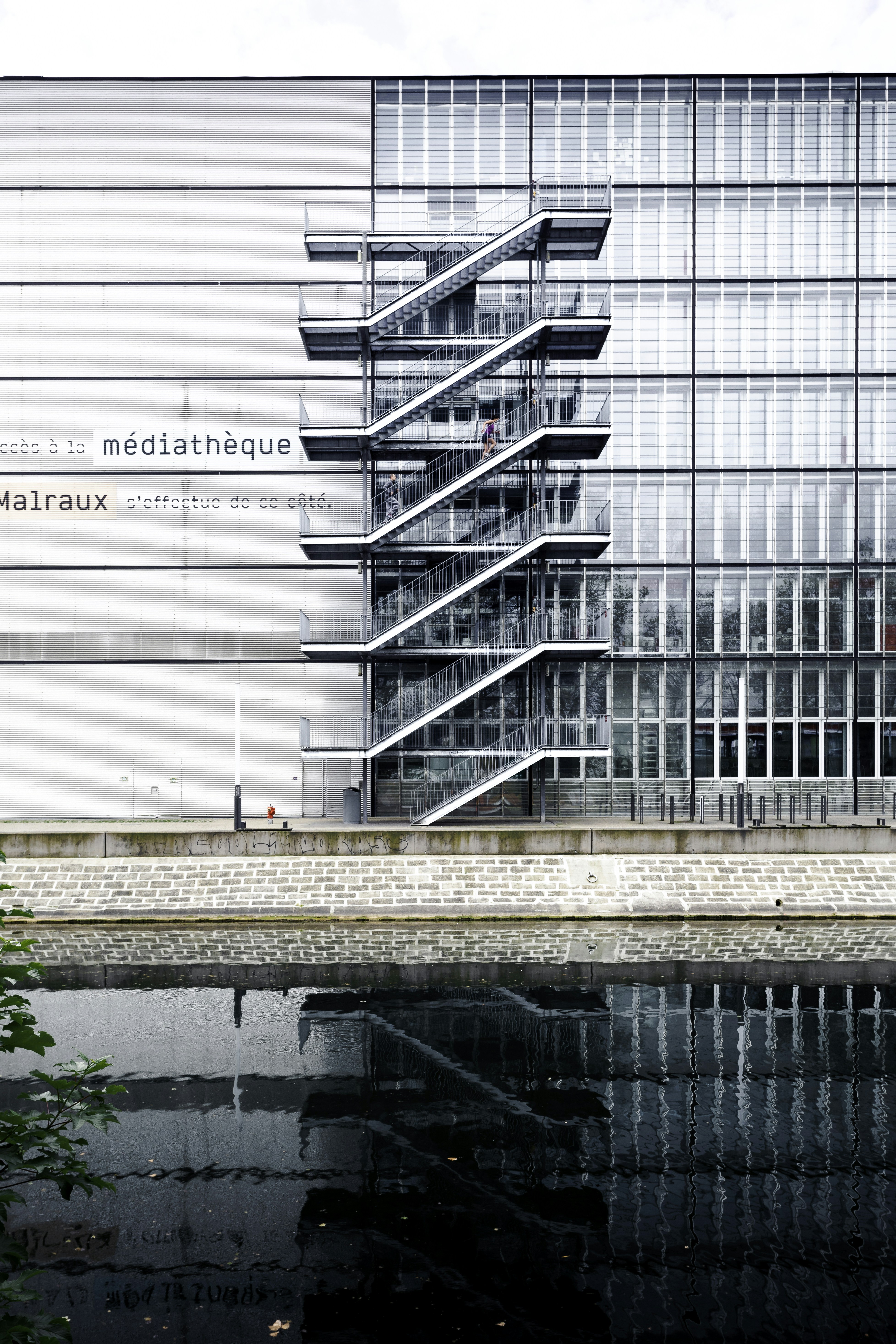Glass Facade and Staircase Echoes Over the River