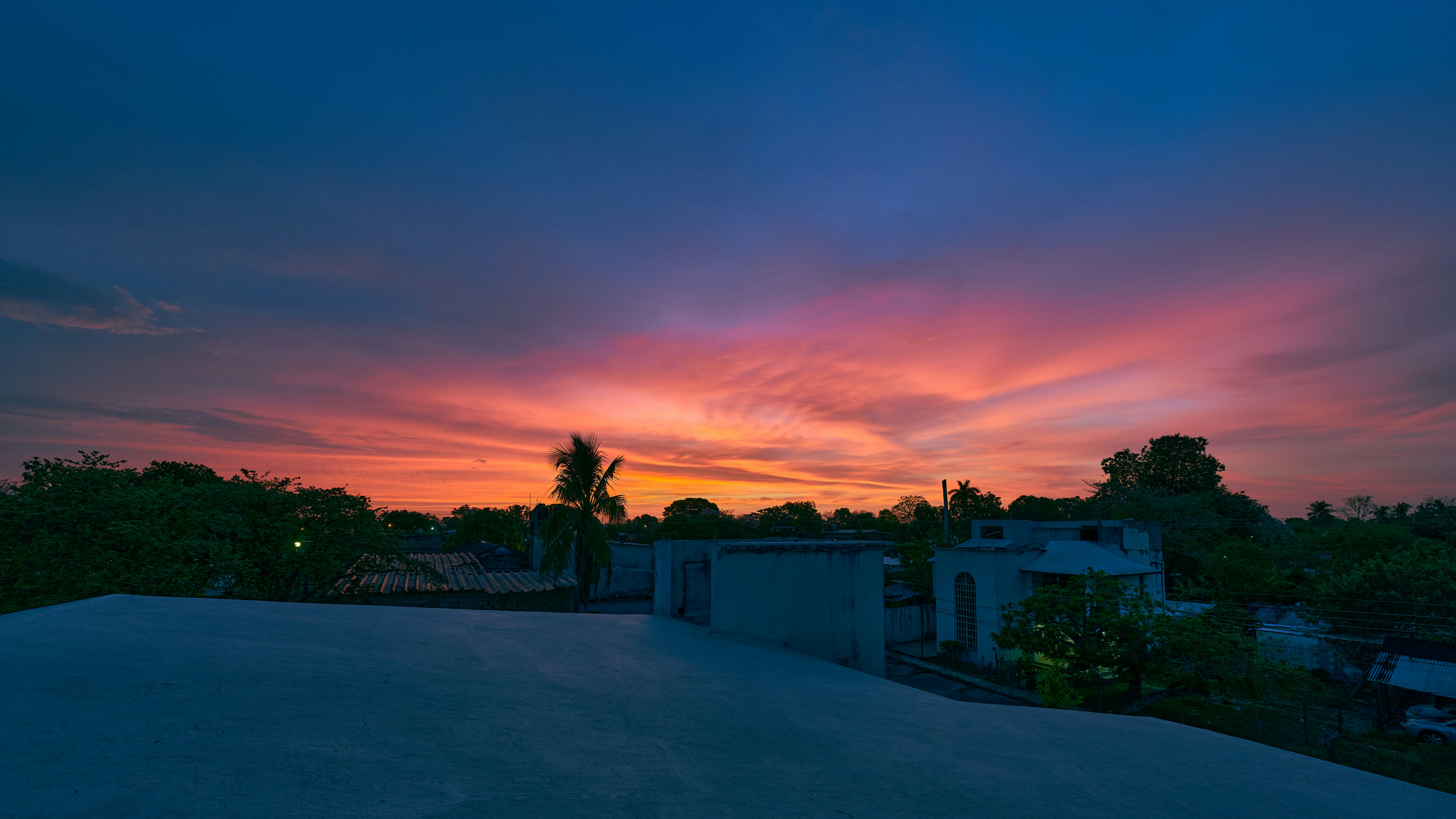 Blue golden hour transition  | white and brown concrete building near body of water during sunset