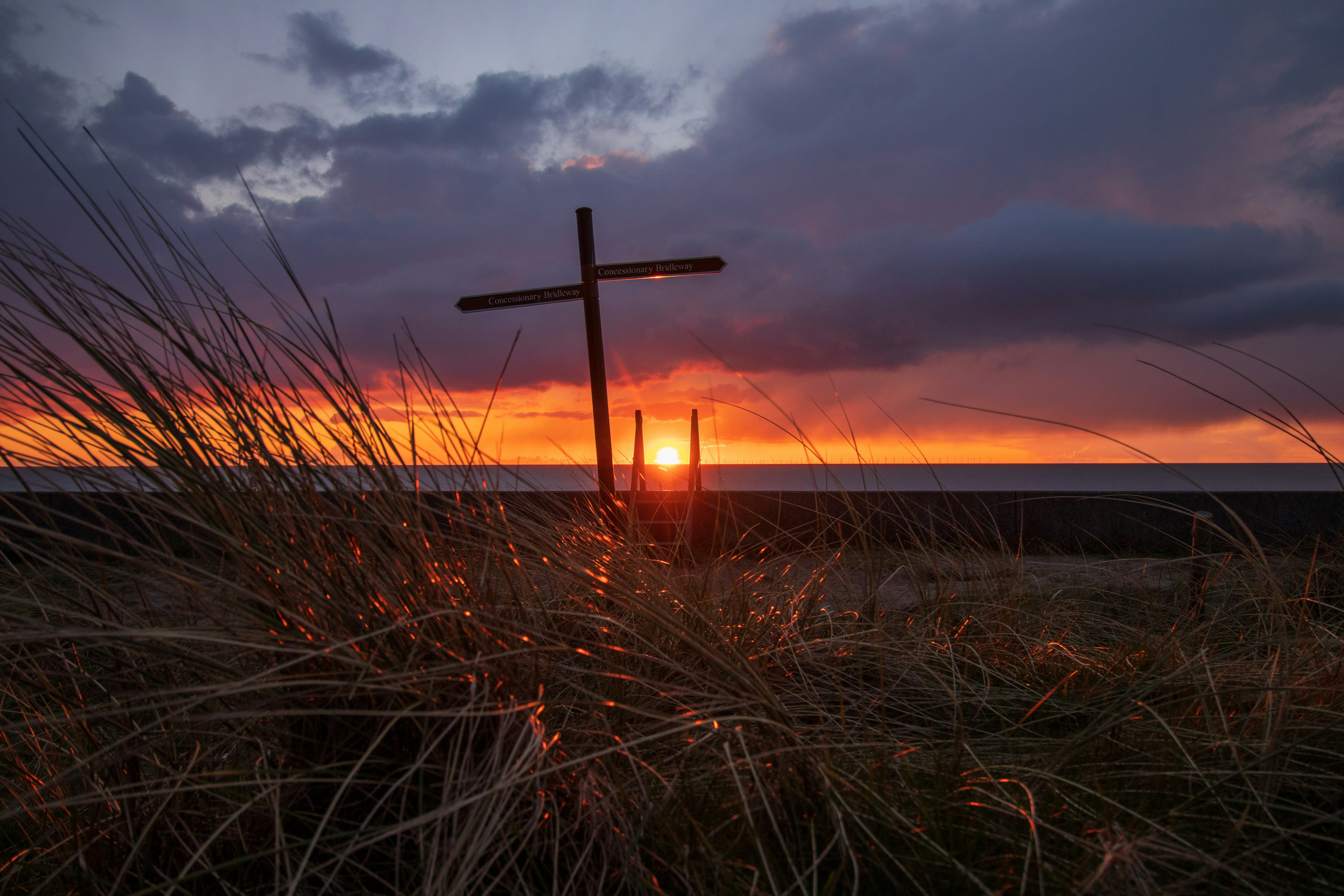 Sunlit Cross Against a Fiery Horizon