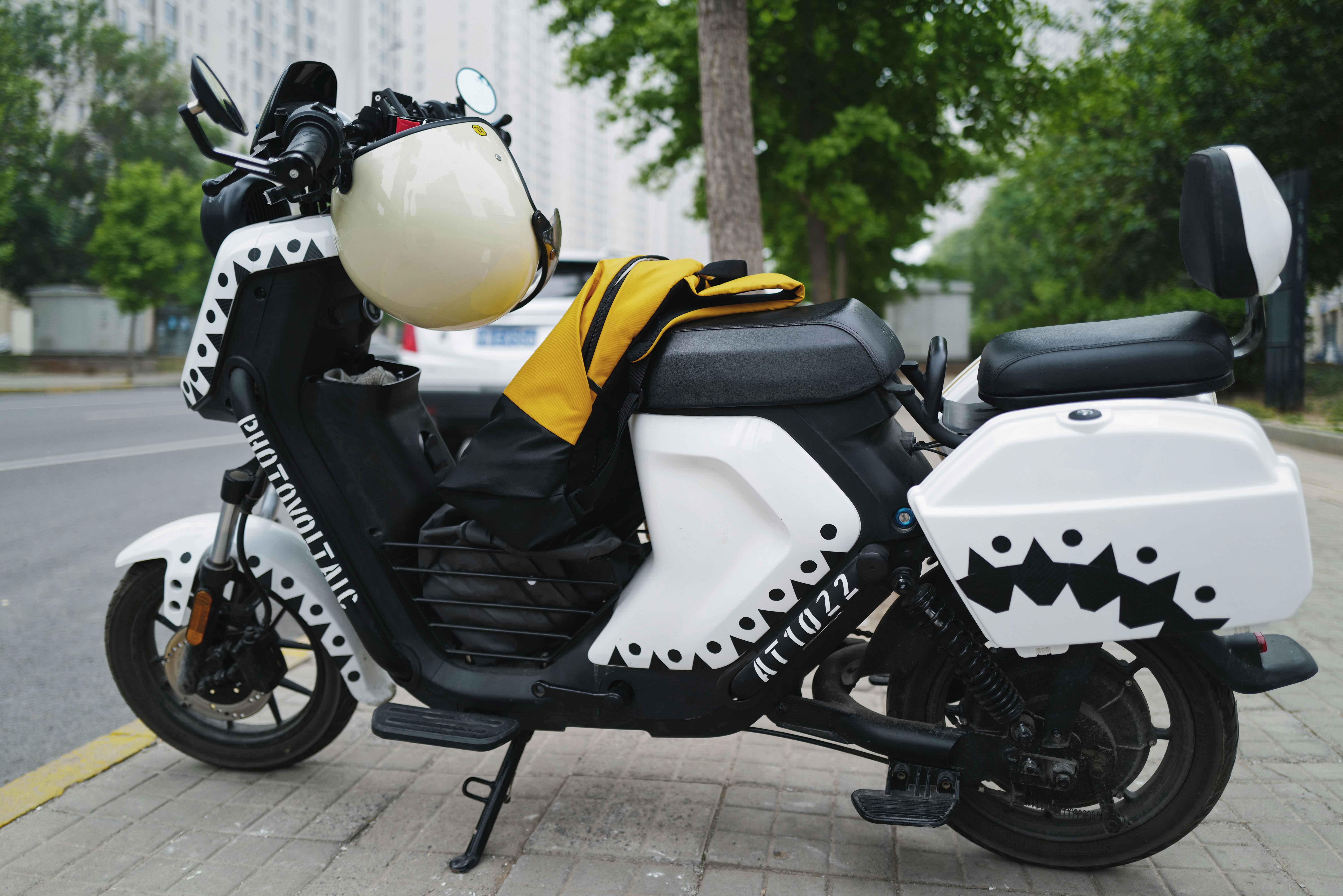 Jagged-Trim Cruiser: White motorcycle with bold zigzag detailing on a quiet city street
