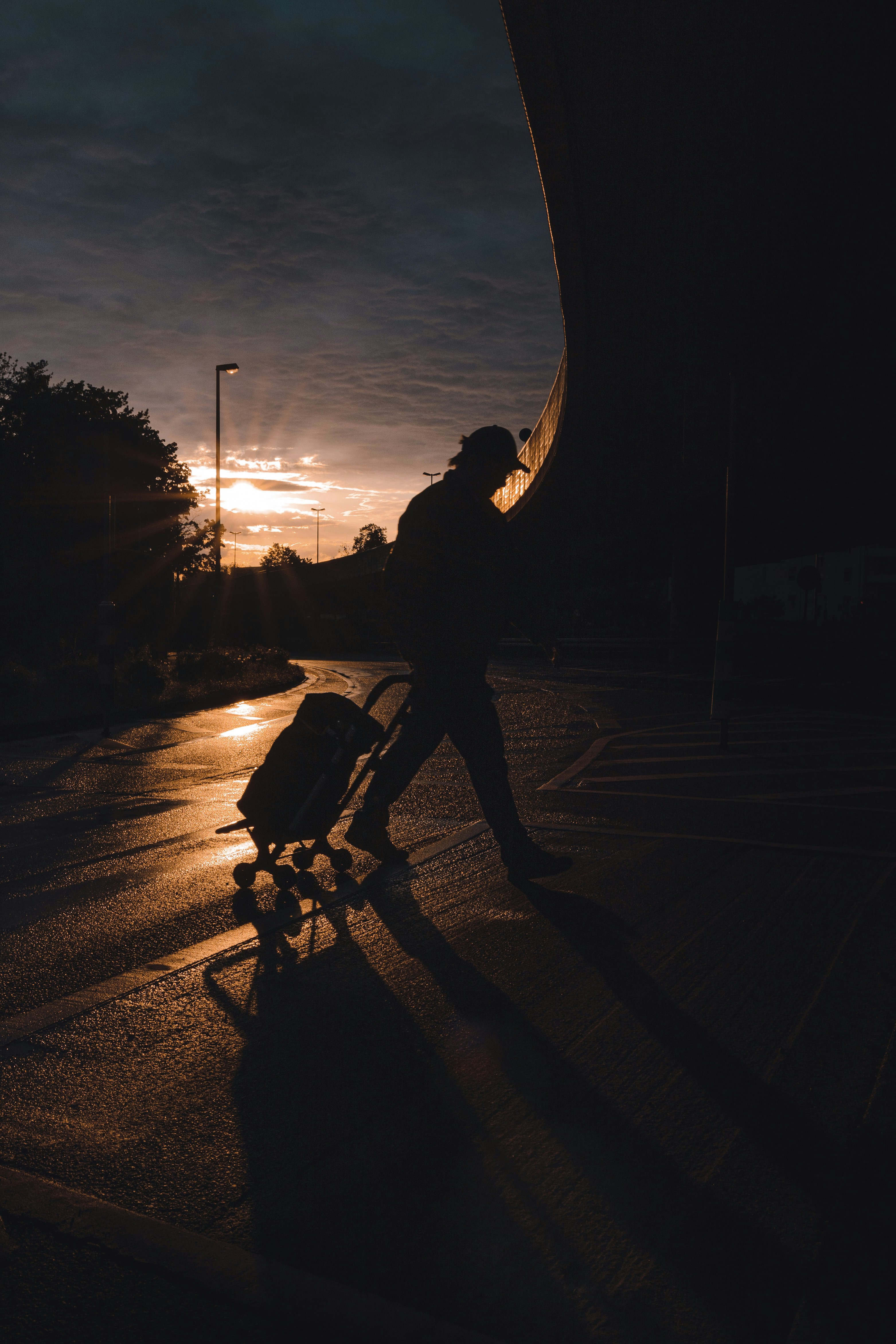 Silhouette at Sunset: The Luggage Wheel Keeps Time