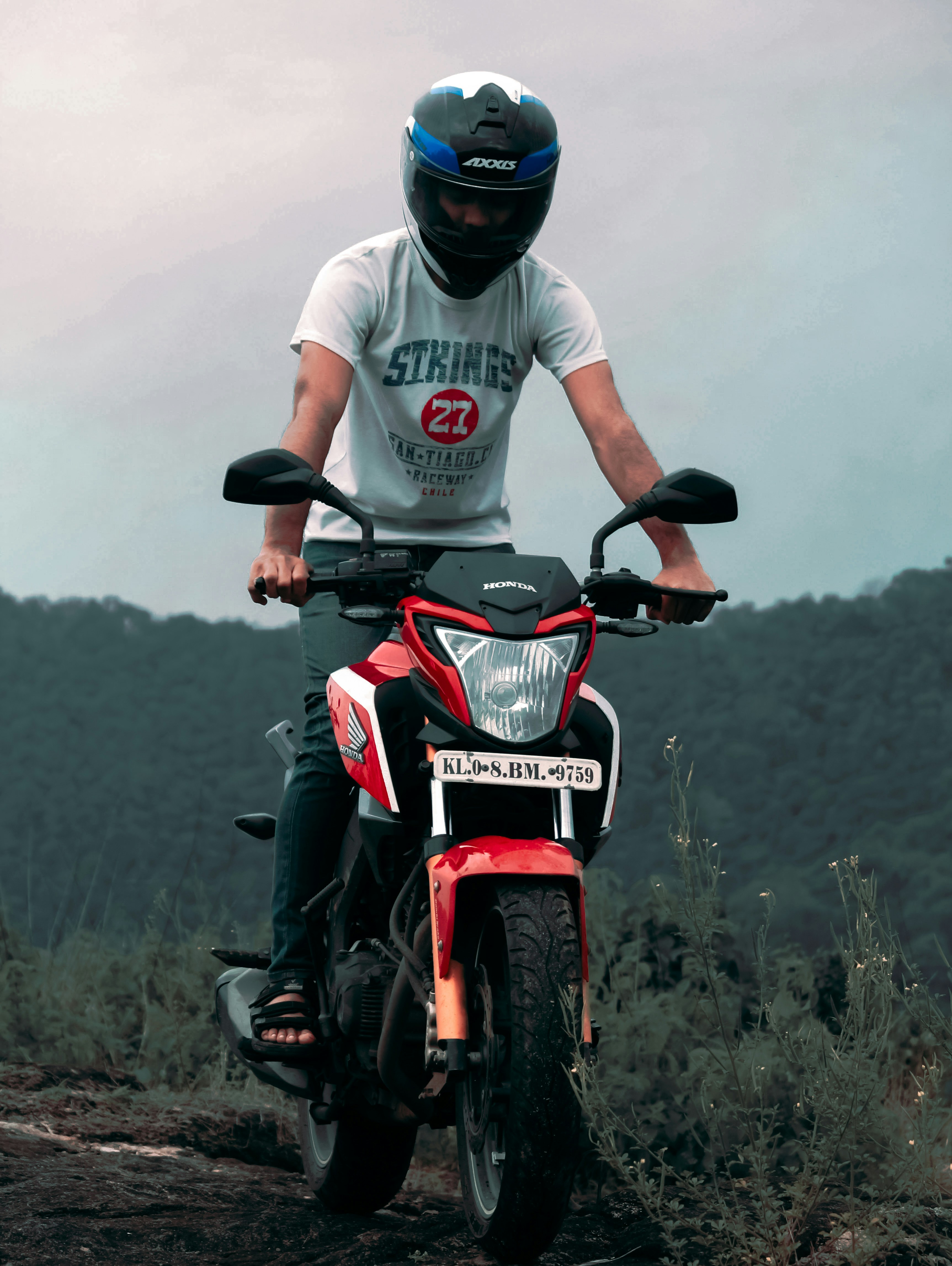 Man in white and red motorcycle helmet riding red and black motorcycle ...