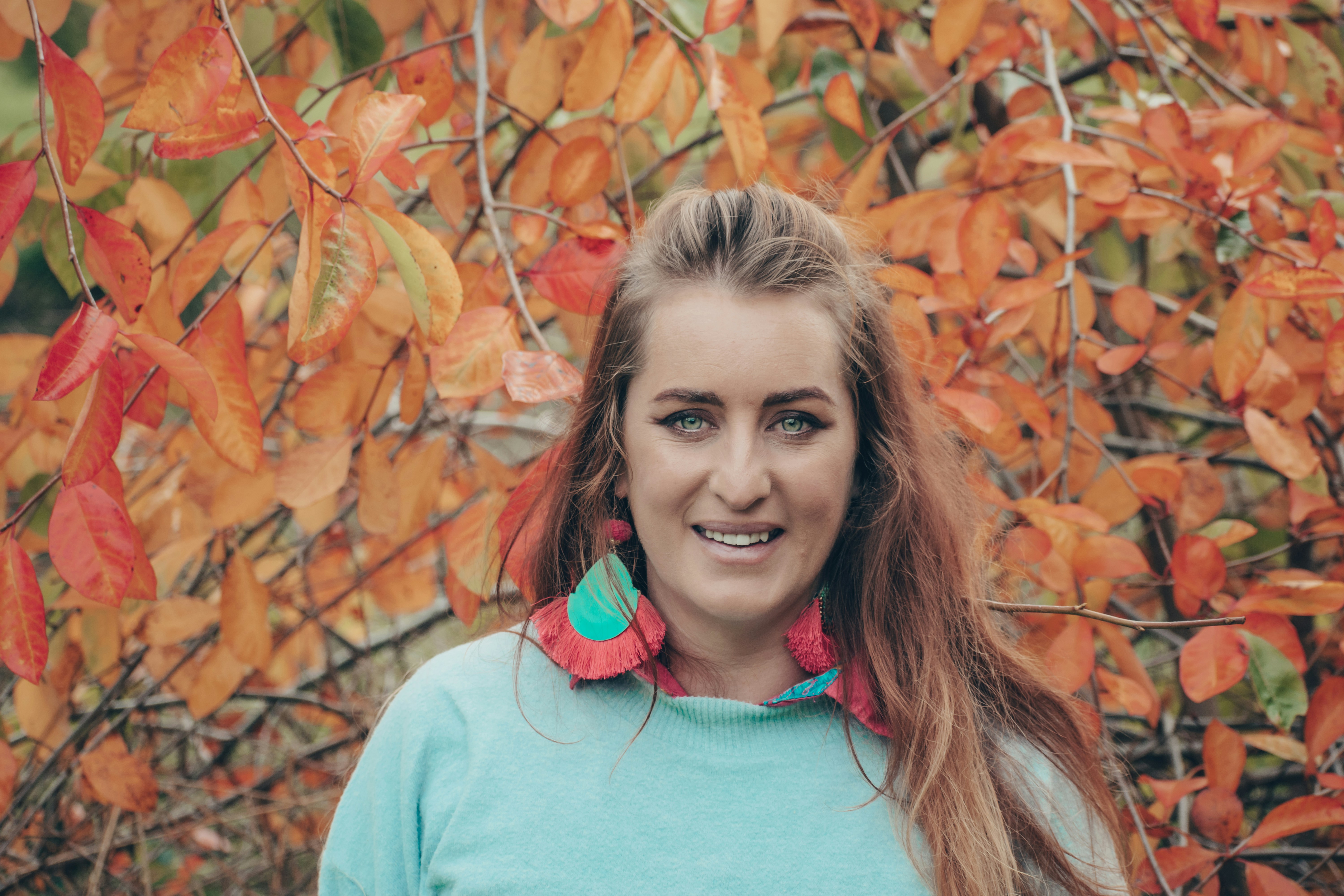 Autumn Portrait: A Smiling Moment Amid Orange Leaves