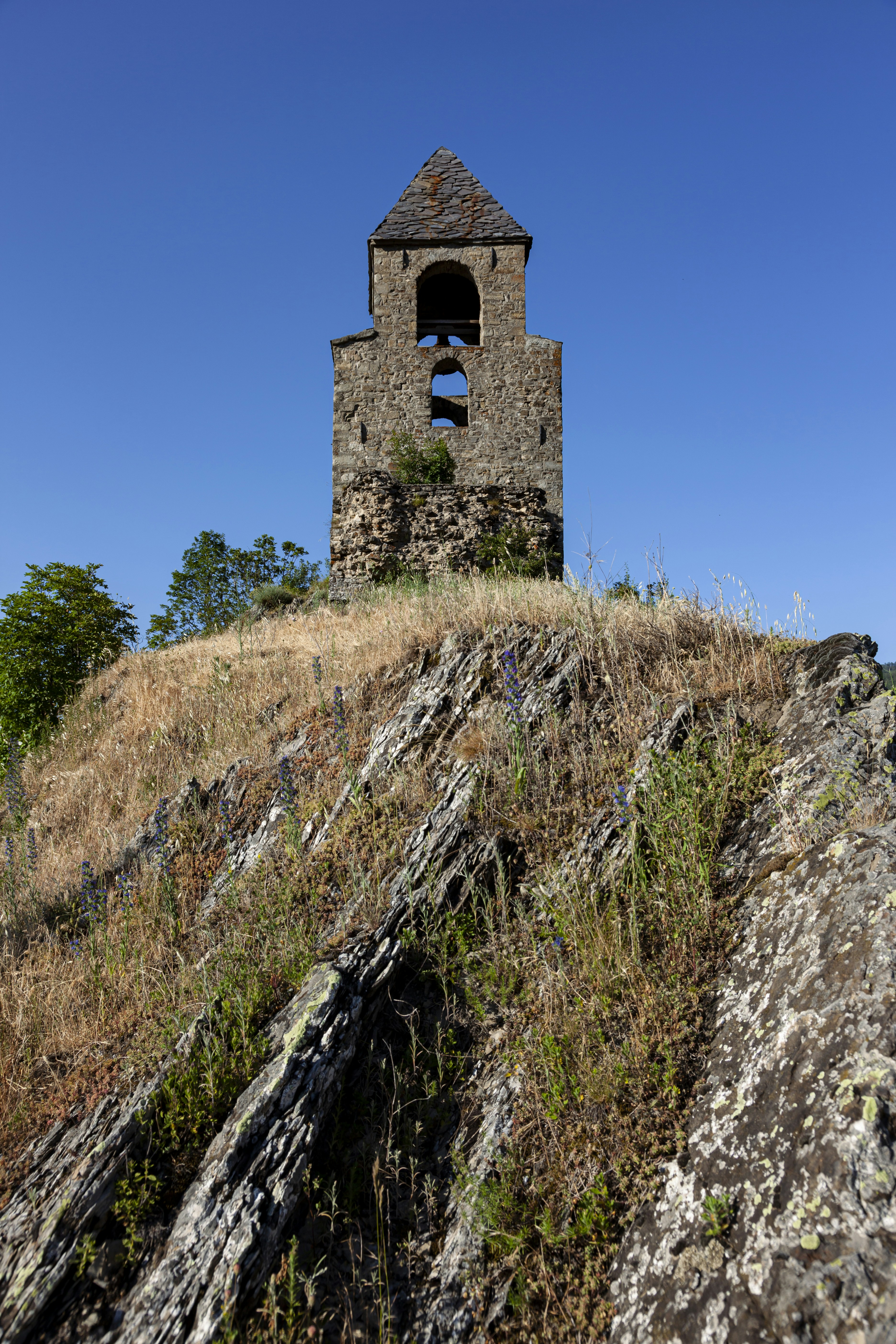 Brown concrete building on green grass field under blue sky during ...