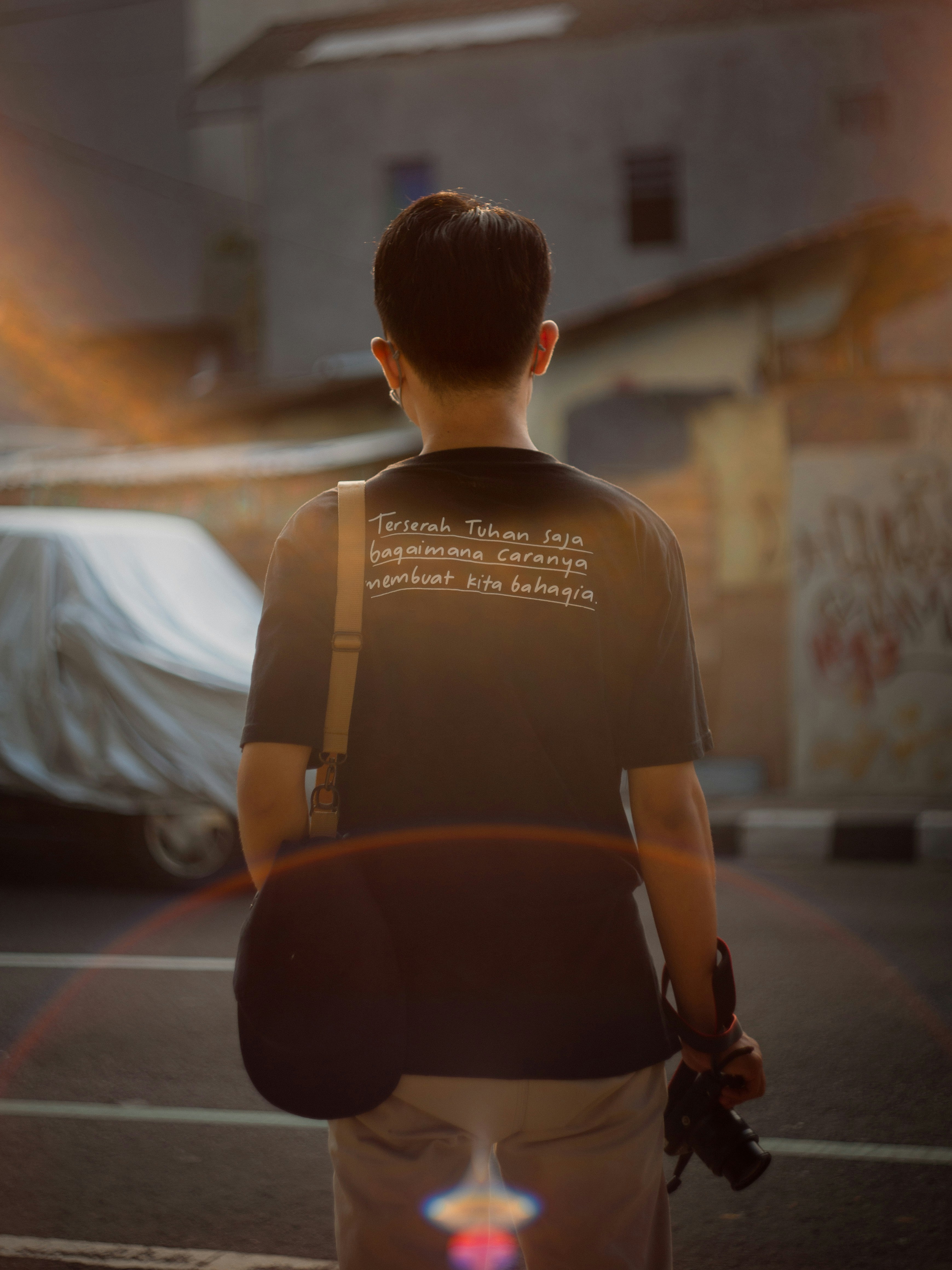 Backlit Street Portrait: A Solo Photographer in Sunset Glow