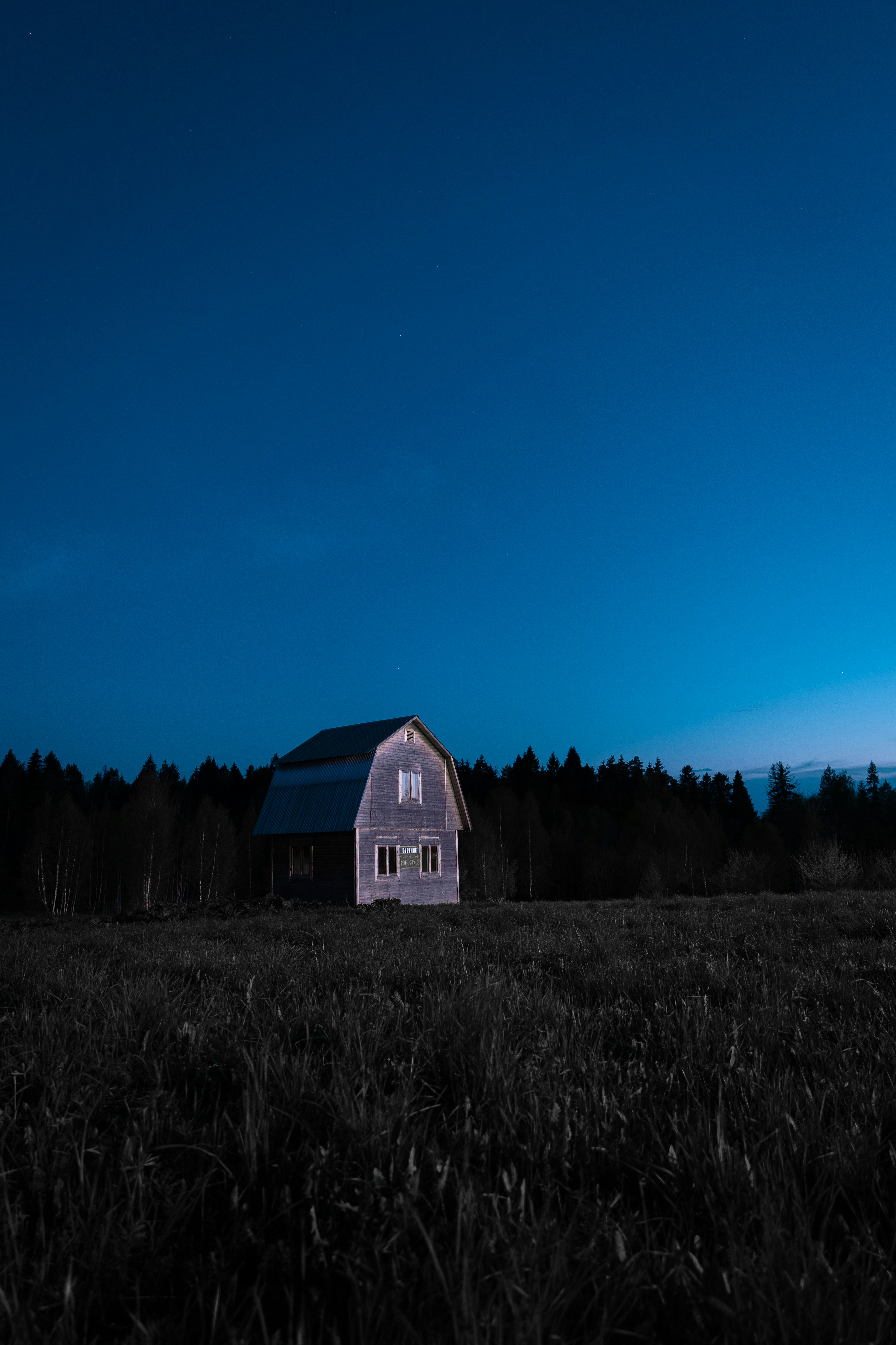 Blue Hour Solitude: A Lone Cabin Beneath a Velvet Night Sky