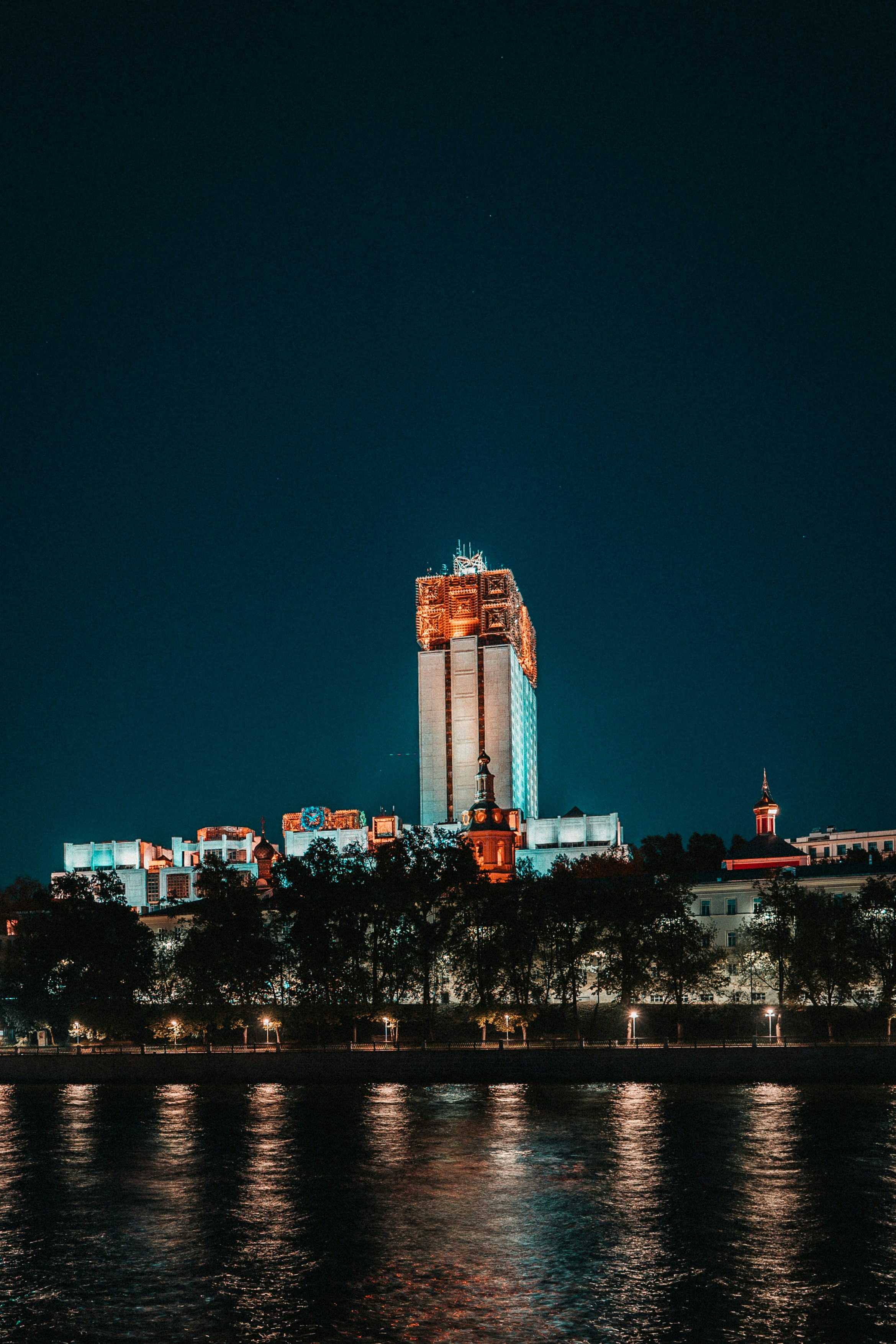 Amber Crown Over Teal Skyline: Nighttime Reflections by the River