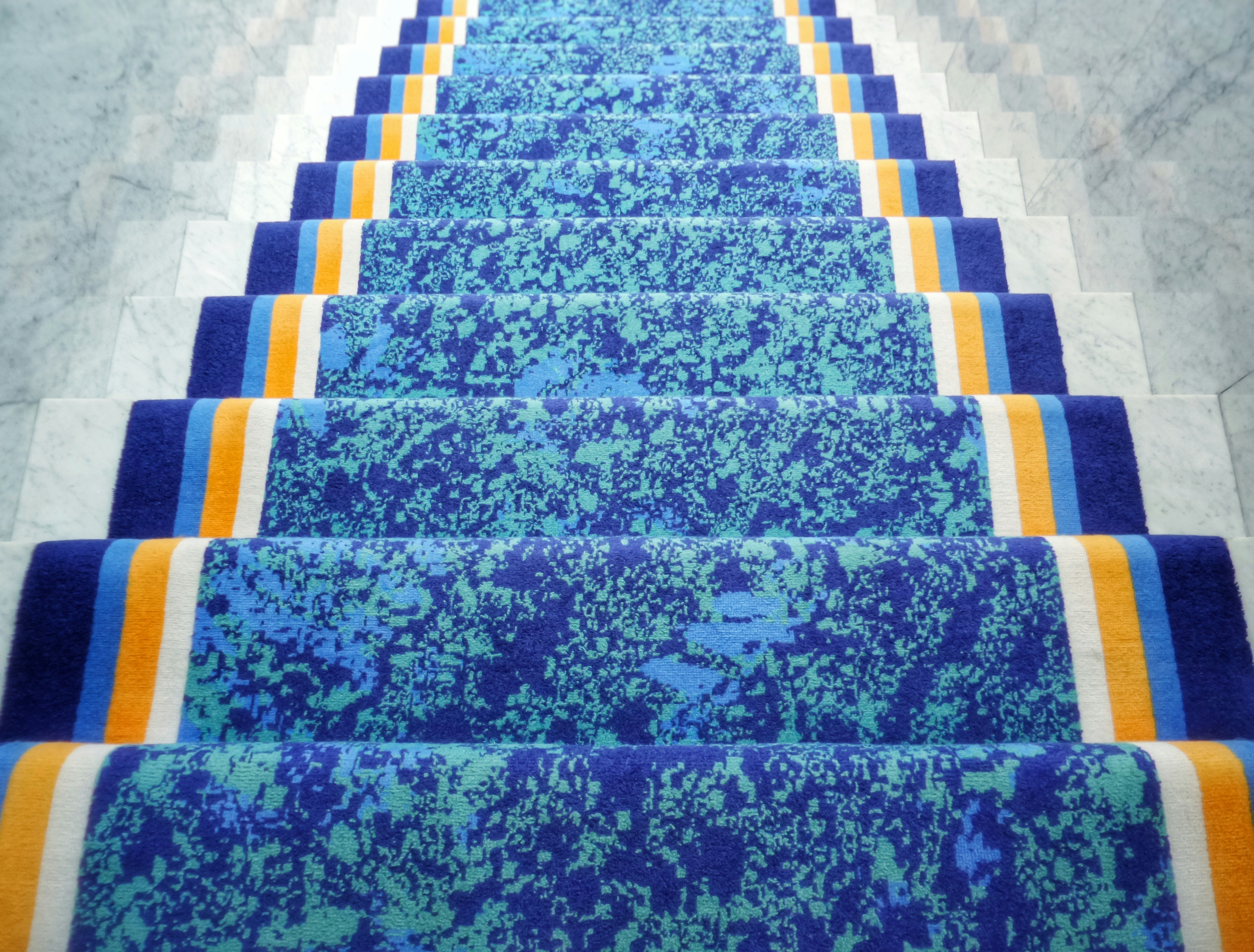 Vanishing Blue Staircase: Carpeted Steps Toward a Quiet Horizon