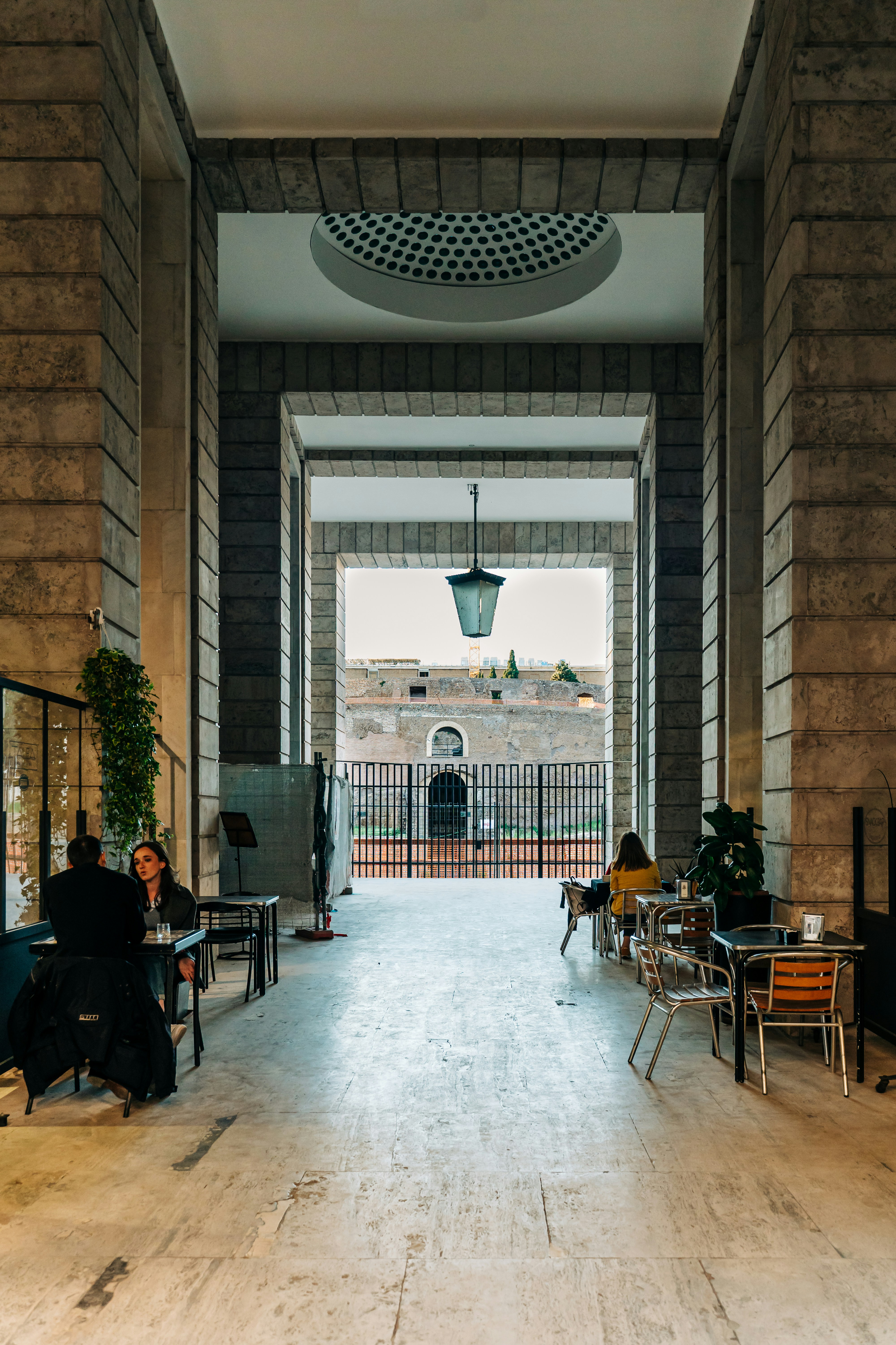 Arches to the Outside: A Corridor Café Framed by Light