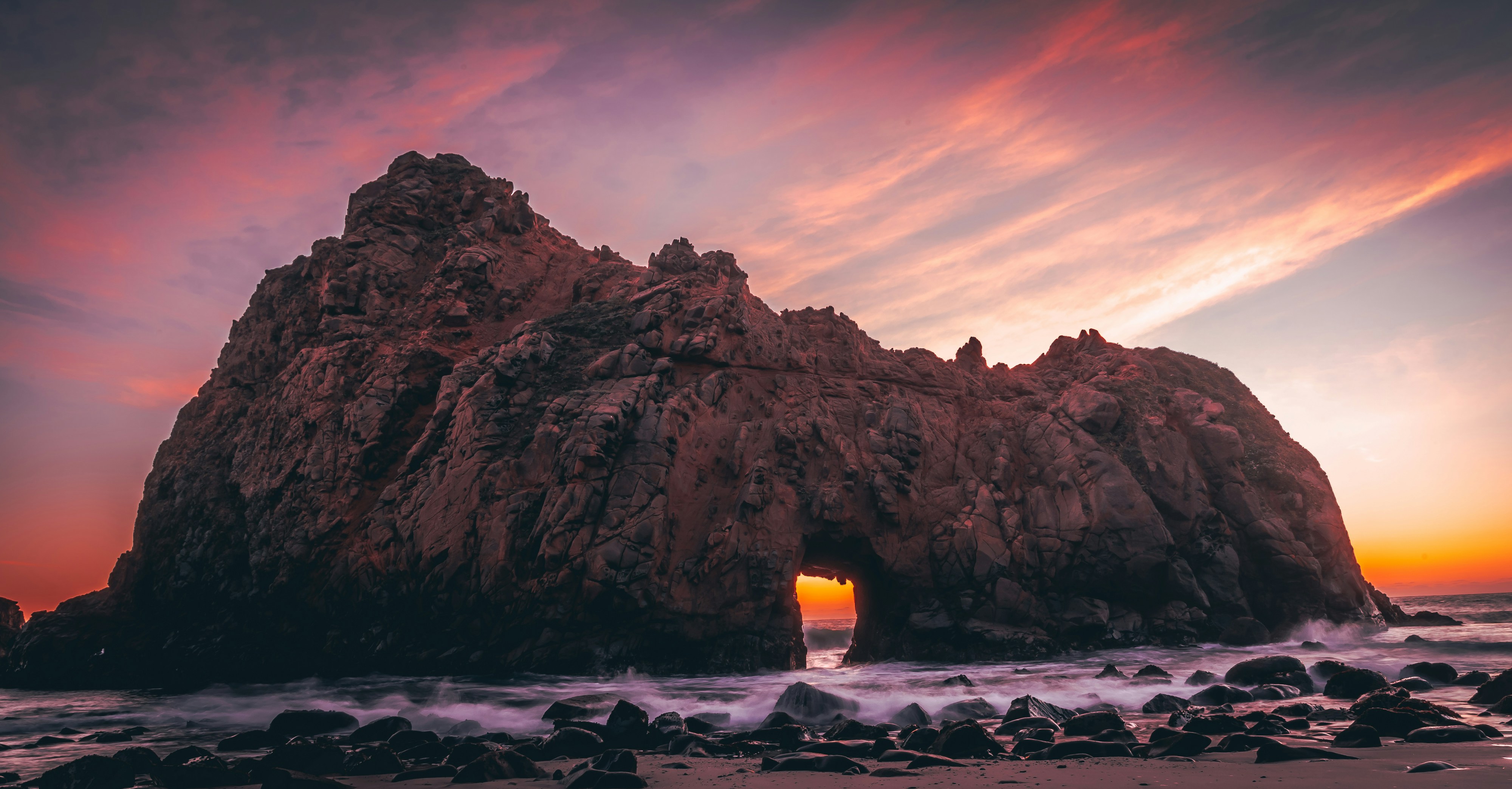 Sunset Gate: The Sea Arch Emerges from a Fiery Horizon