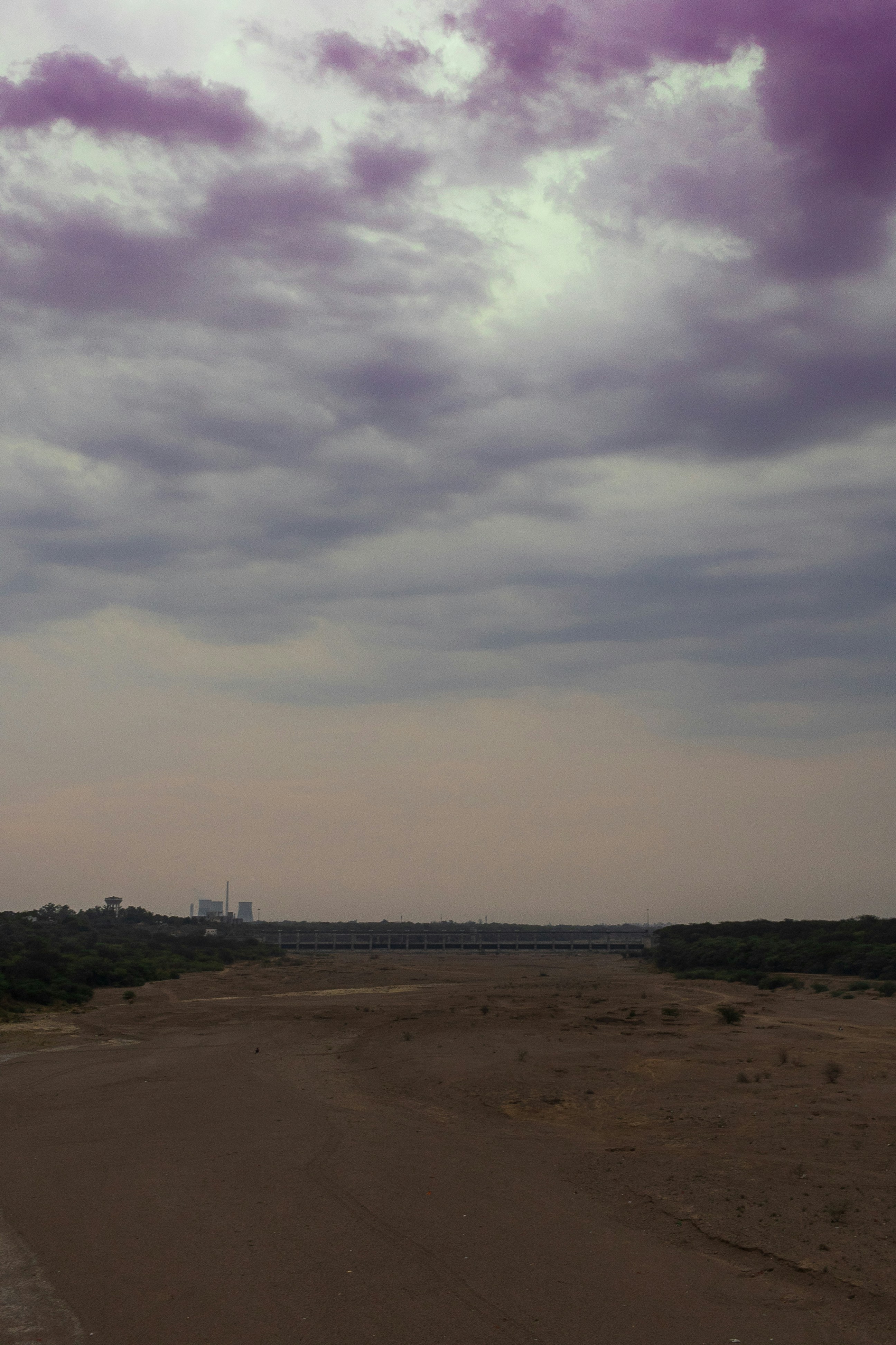 Dust Road to a Quiet Horizon: Distant Skyline Under Lavender Clouds