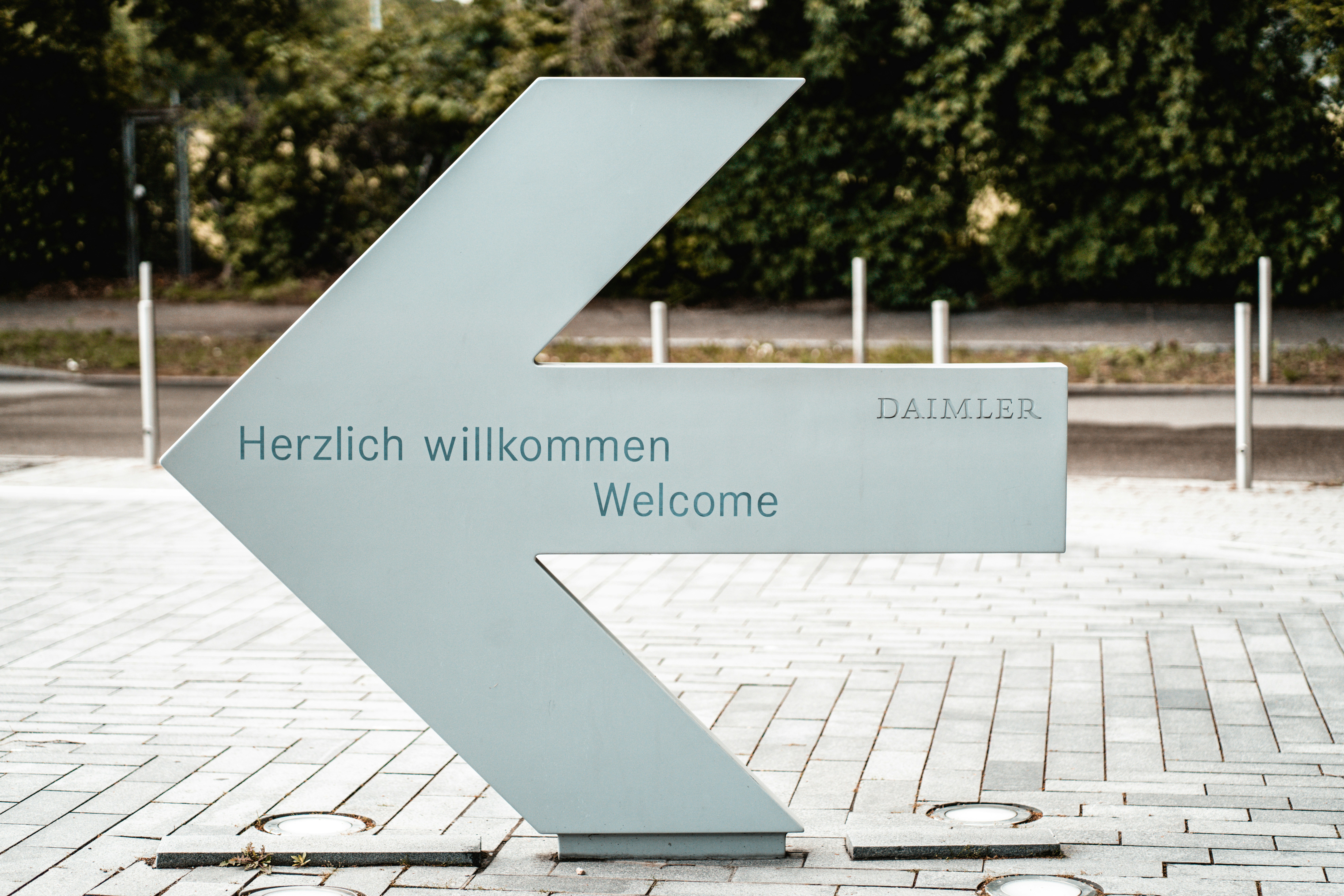 Leftward Welcome: The Daimler Arrow Anchoring a Sunlit Plaza