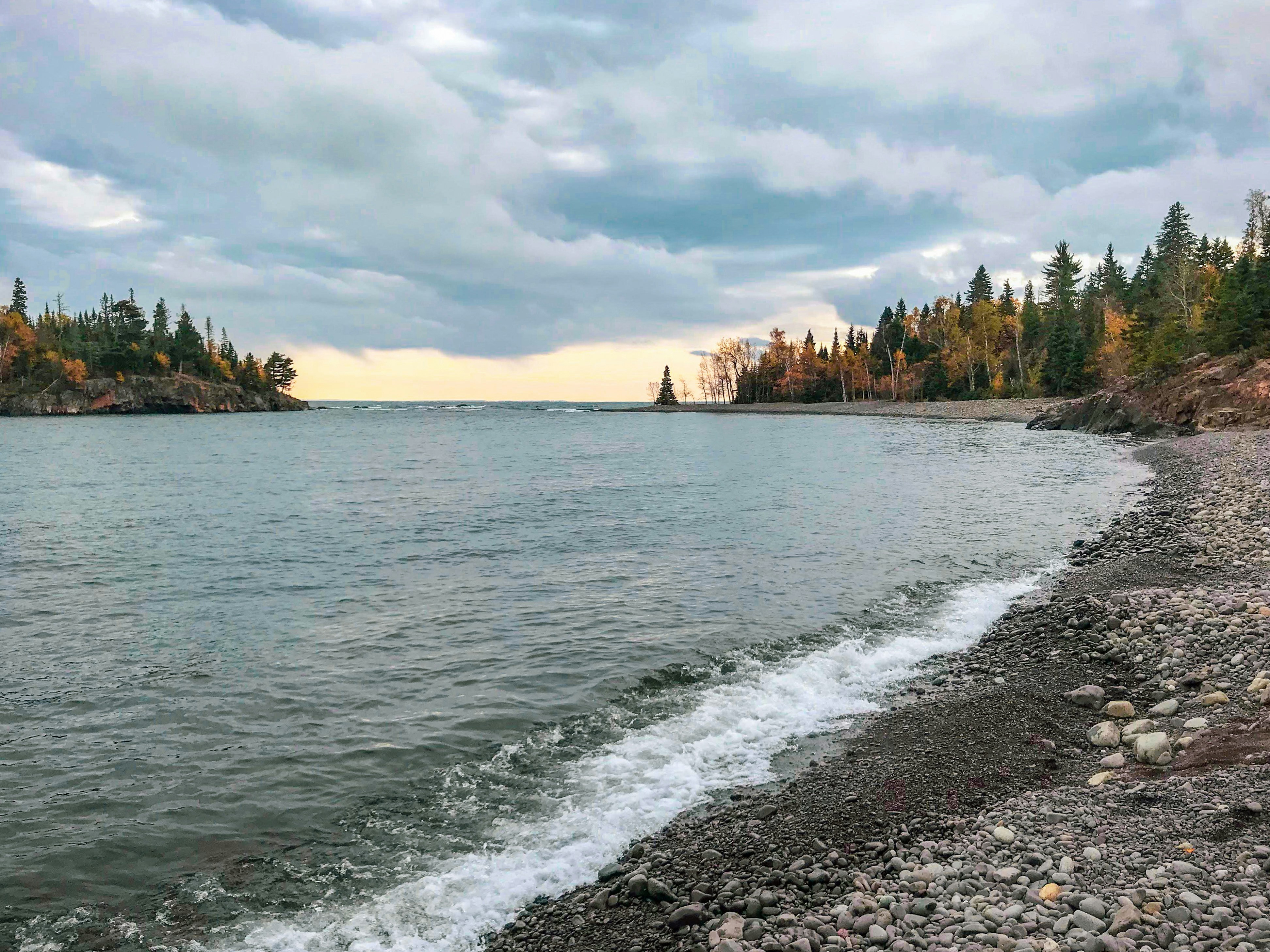 The north shore in autumn. Duluth, MN. | green trees beside body of water during daytime