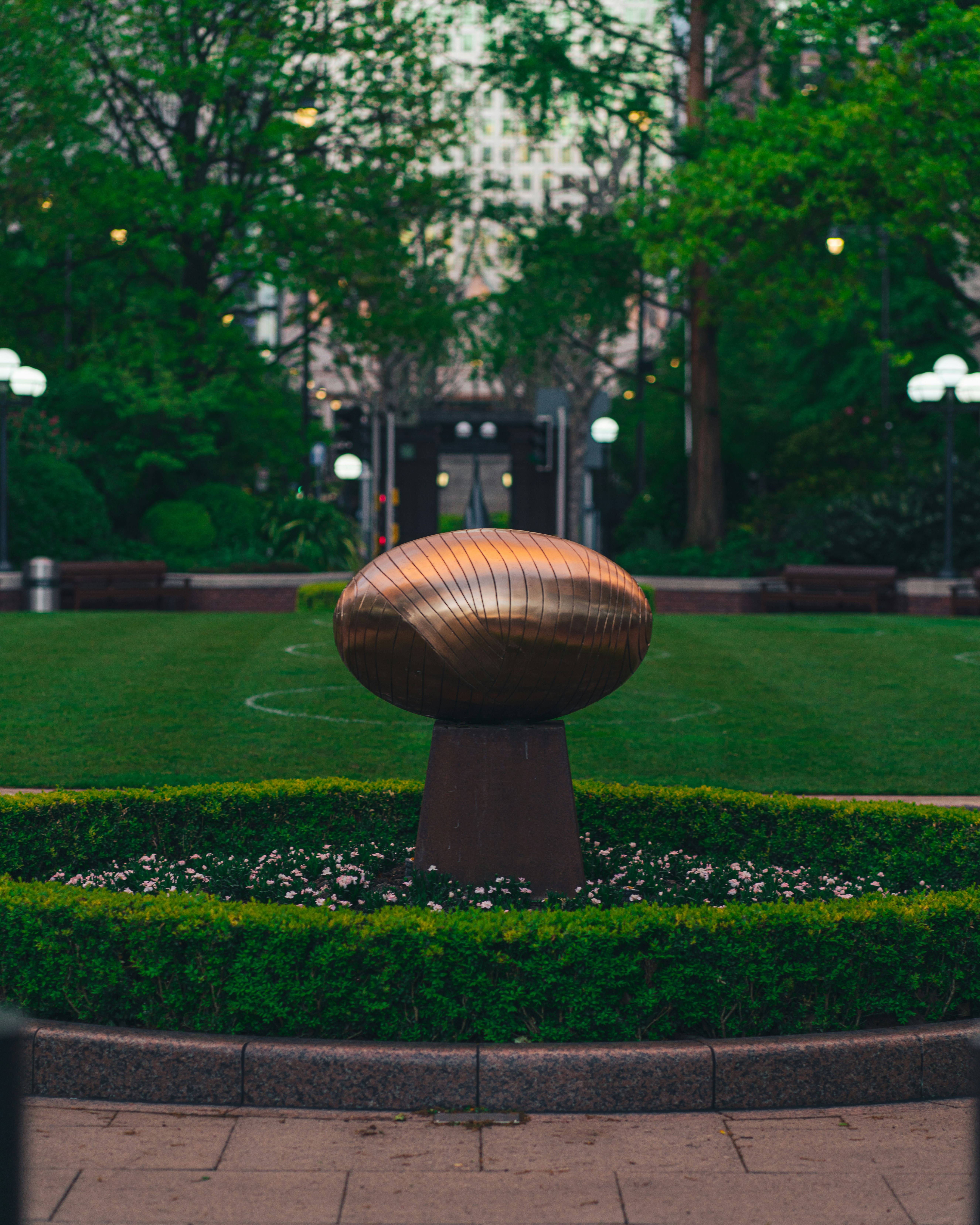 Copper Orb in a City Garden: A Sculpted Pause at Dusk