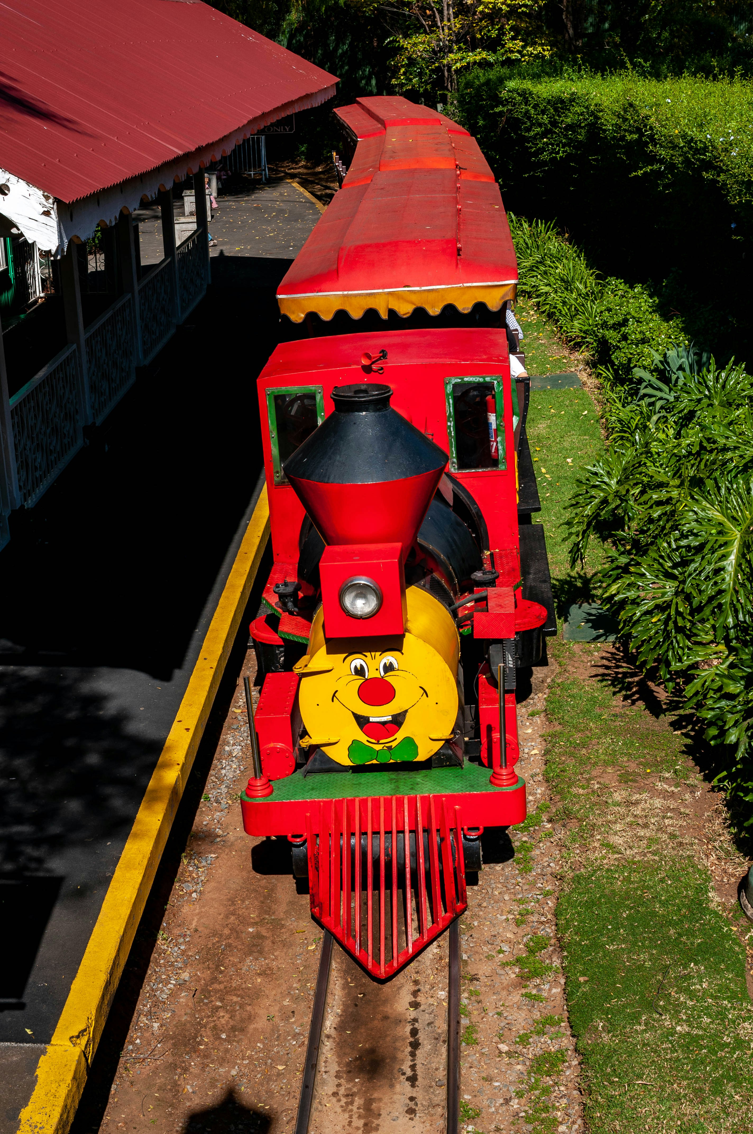 Overhead Portrait of a Playful Red Steam Engine at the Platform