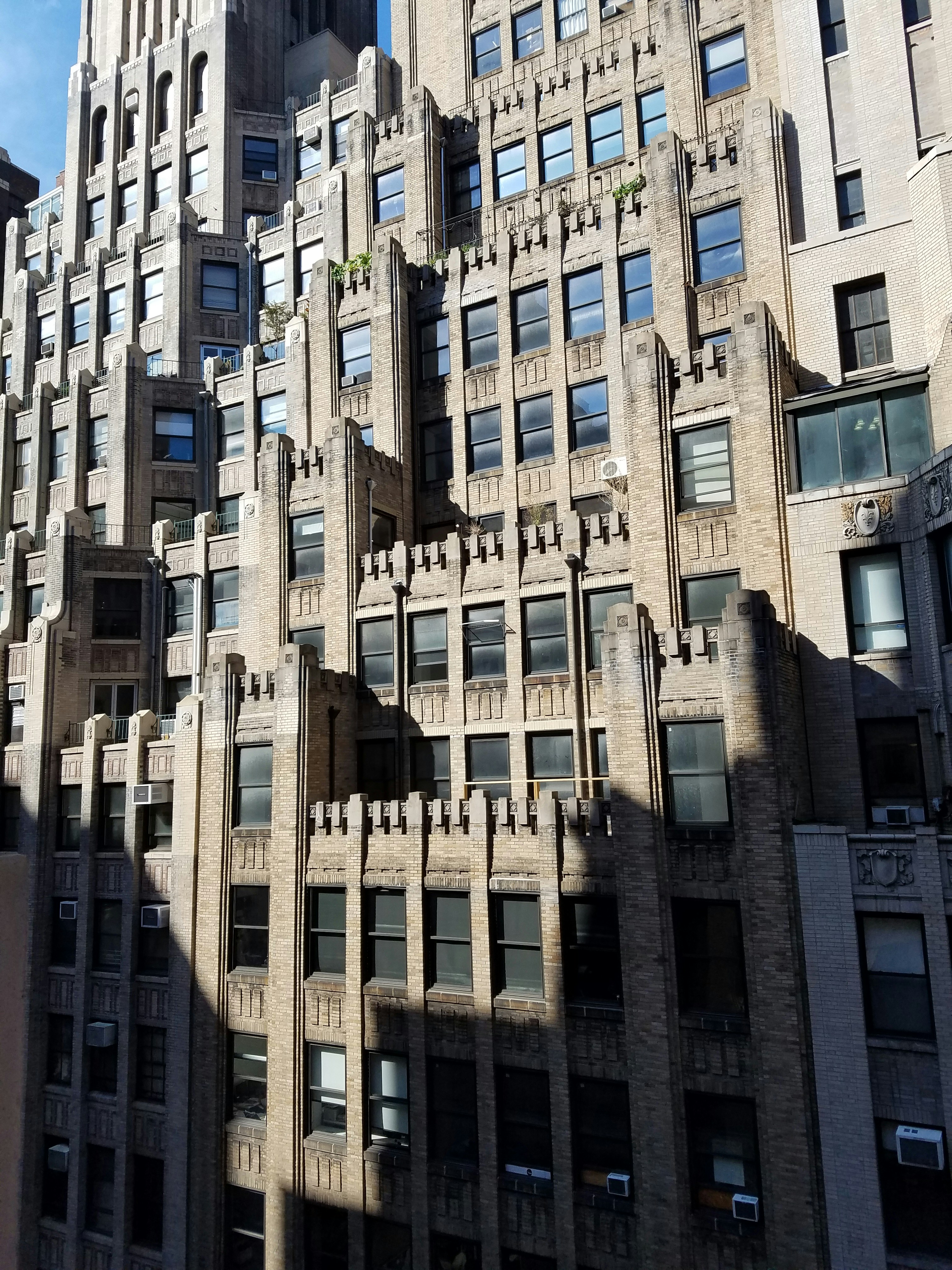 Facade in Focus: Repeating Windows and Light on a Brick Highrise