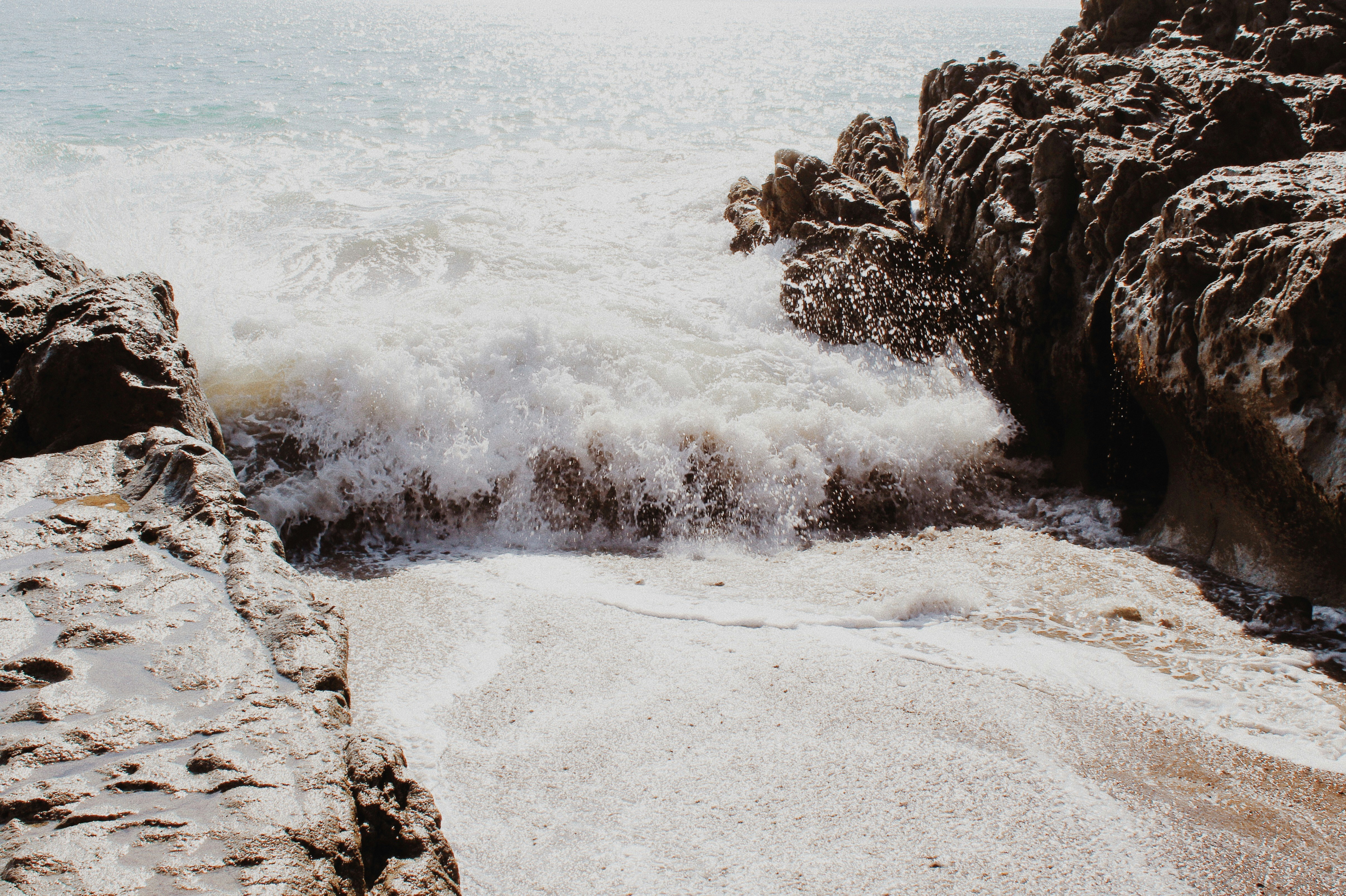 Foam and Granite: A Sunlit Shoreline in Motion