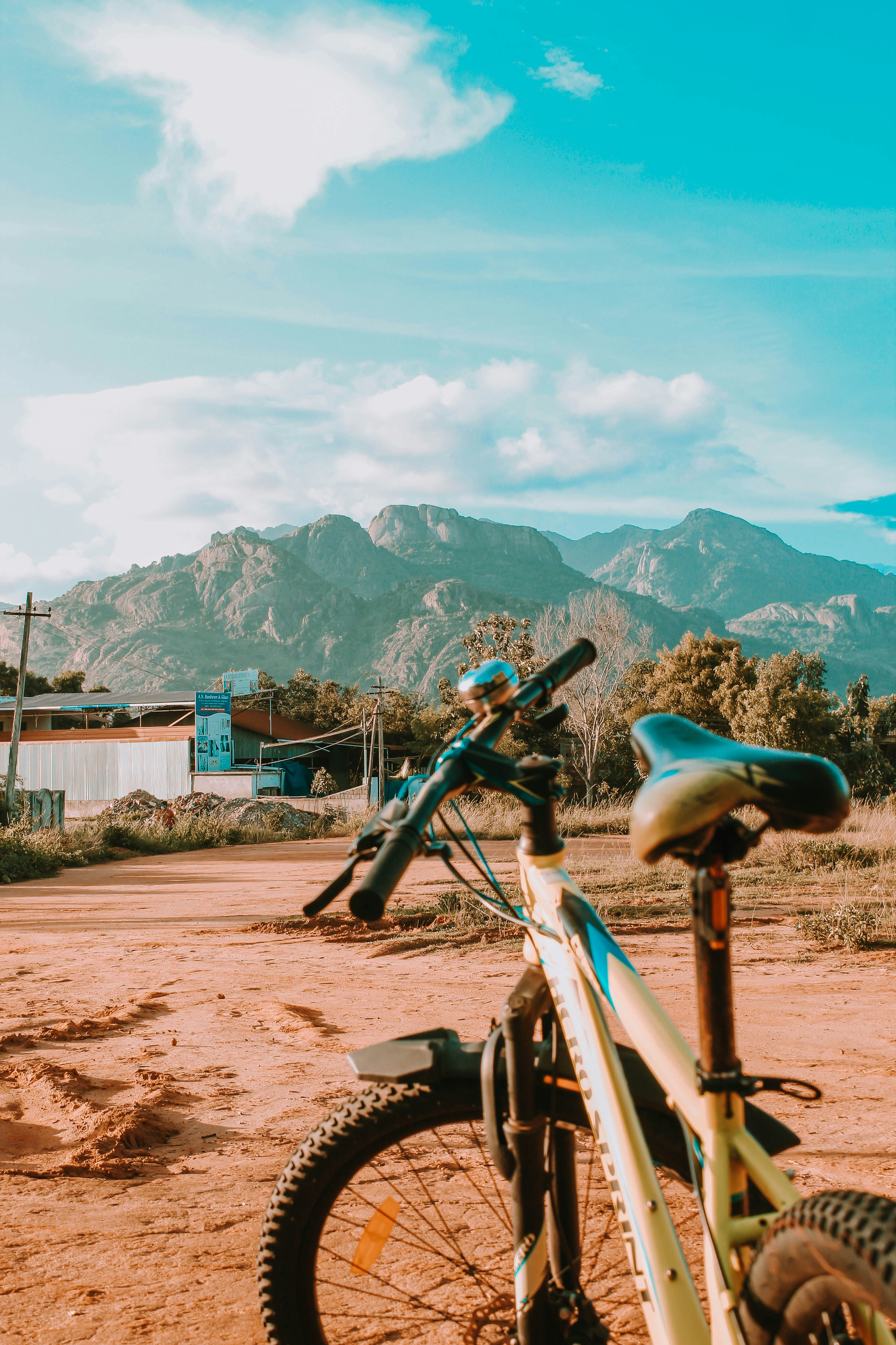 Pastel Pedal on a Dusty Road Before a Majestic Mountain Range