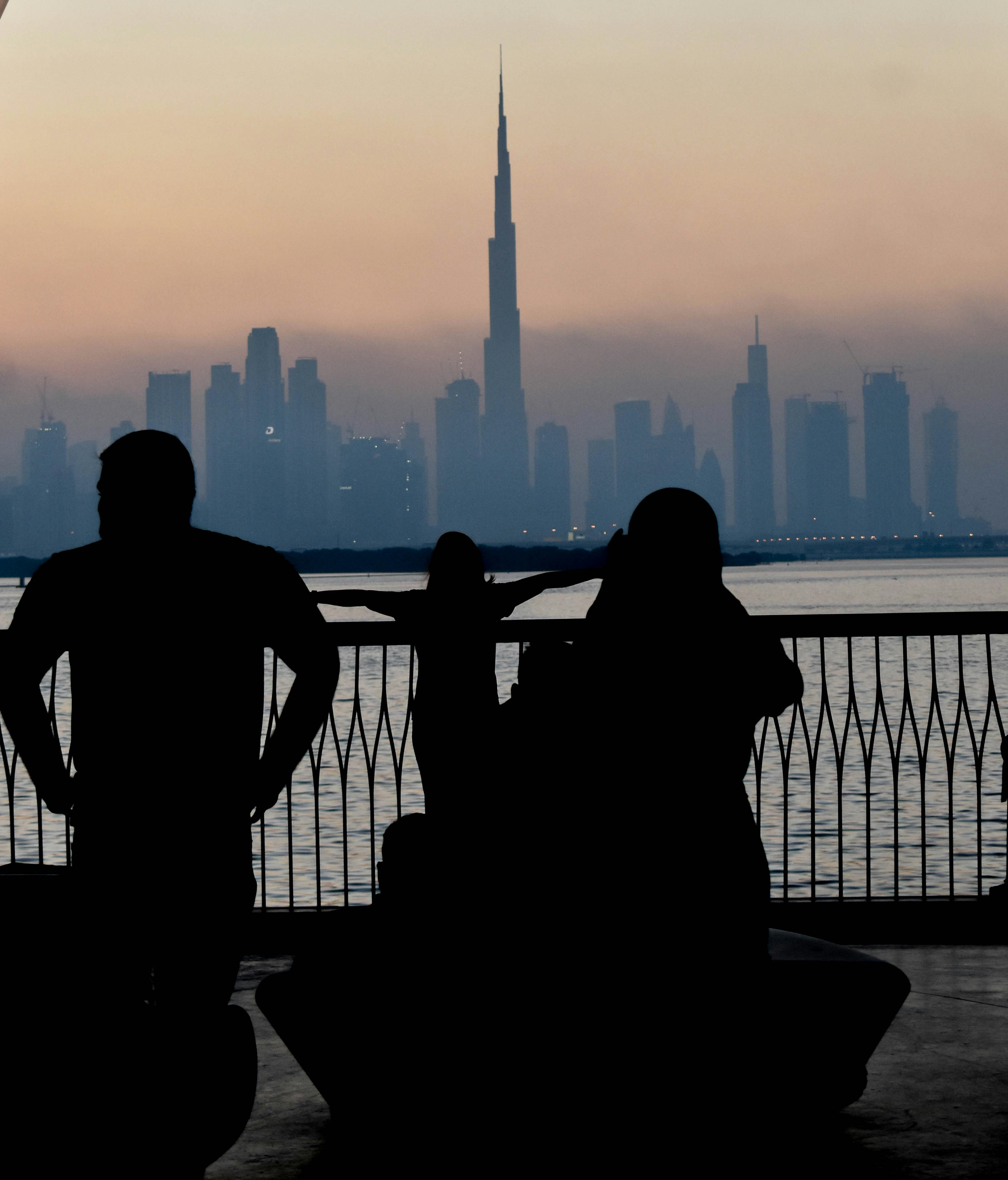 Silhouettes Over the Bay: City Skyline Framed by Nightfall