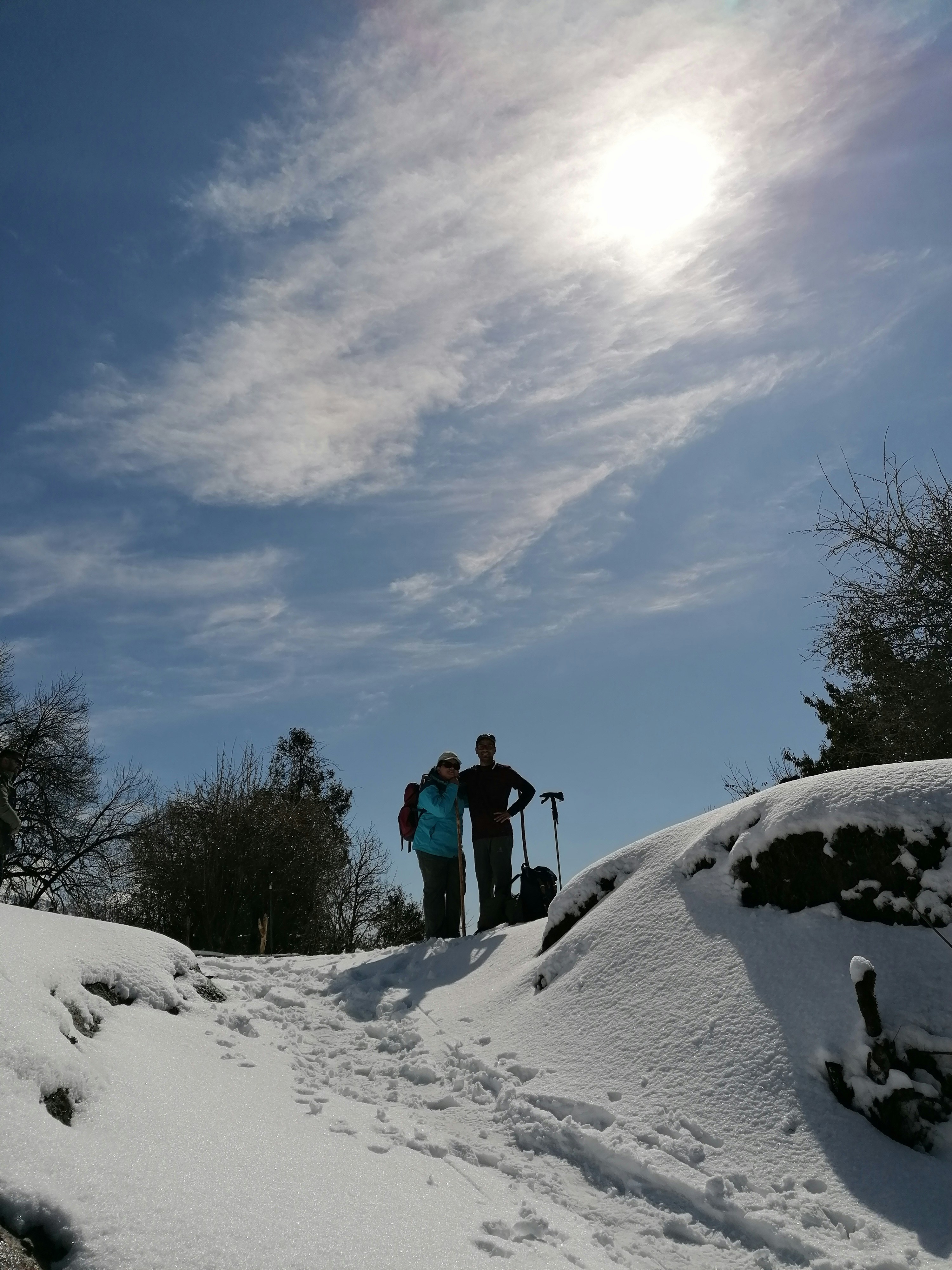 Sunlit Snow Crest: Duo at the Ridge's Edge