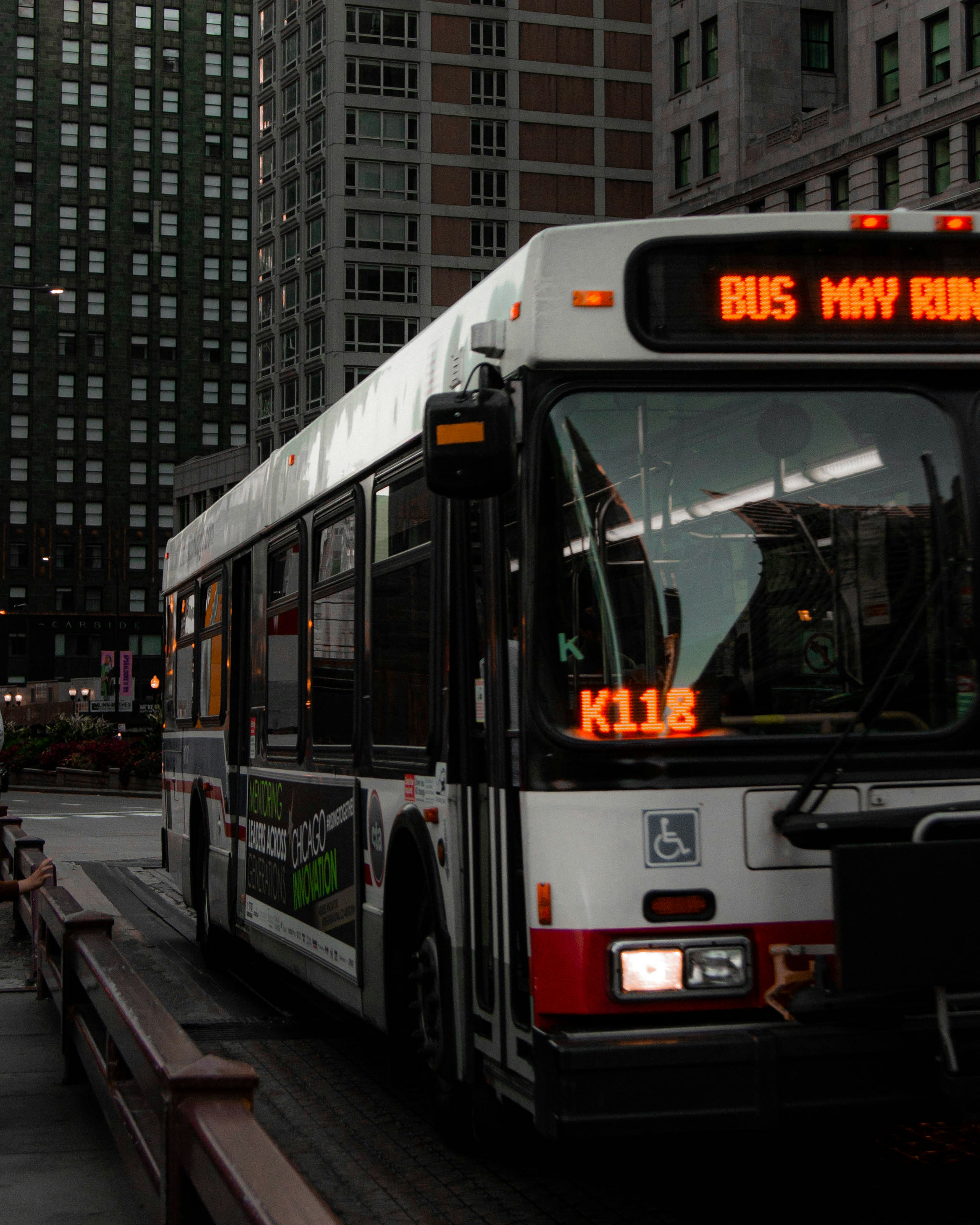 Amber-Display Bus Sign Pierces the City Canyon of Glass and Steel