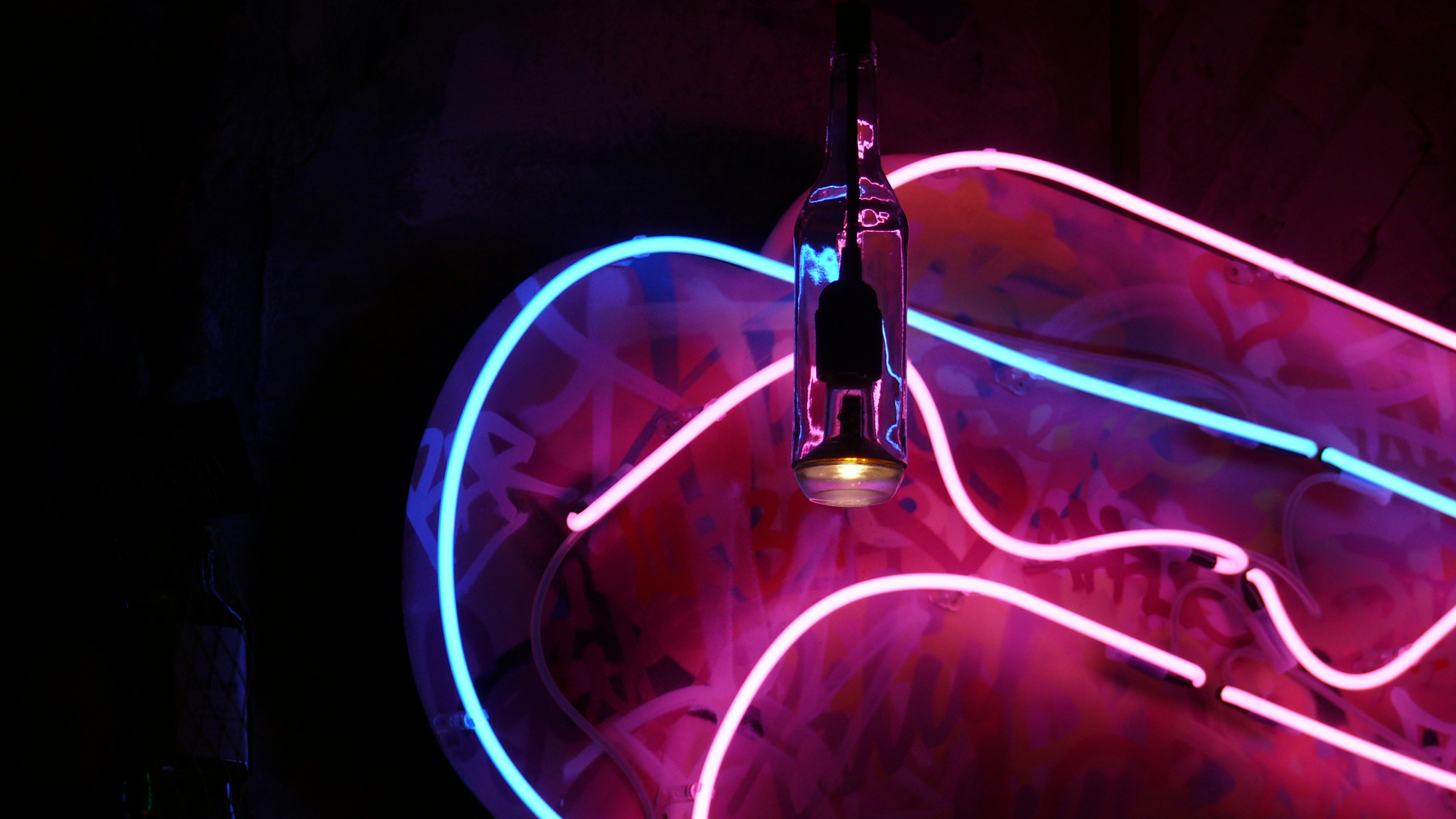 Neon Guitar Silhouette: A Hanging Bottle in Blue and Pink Light