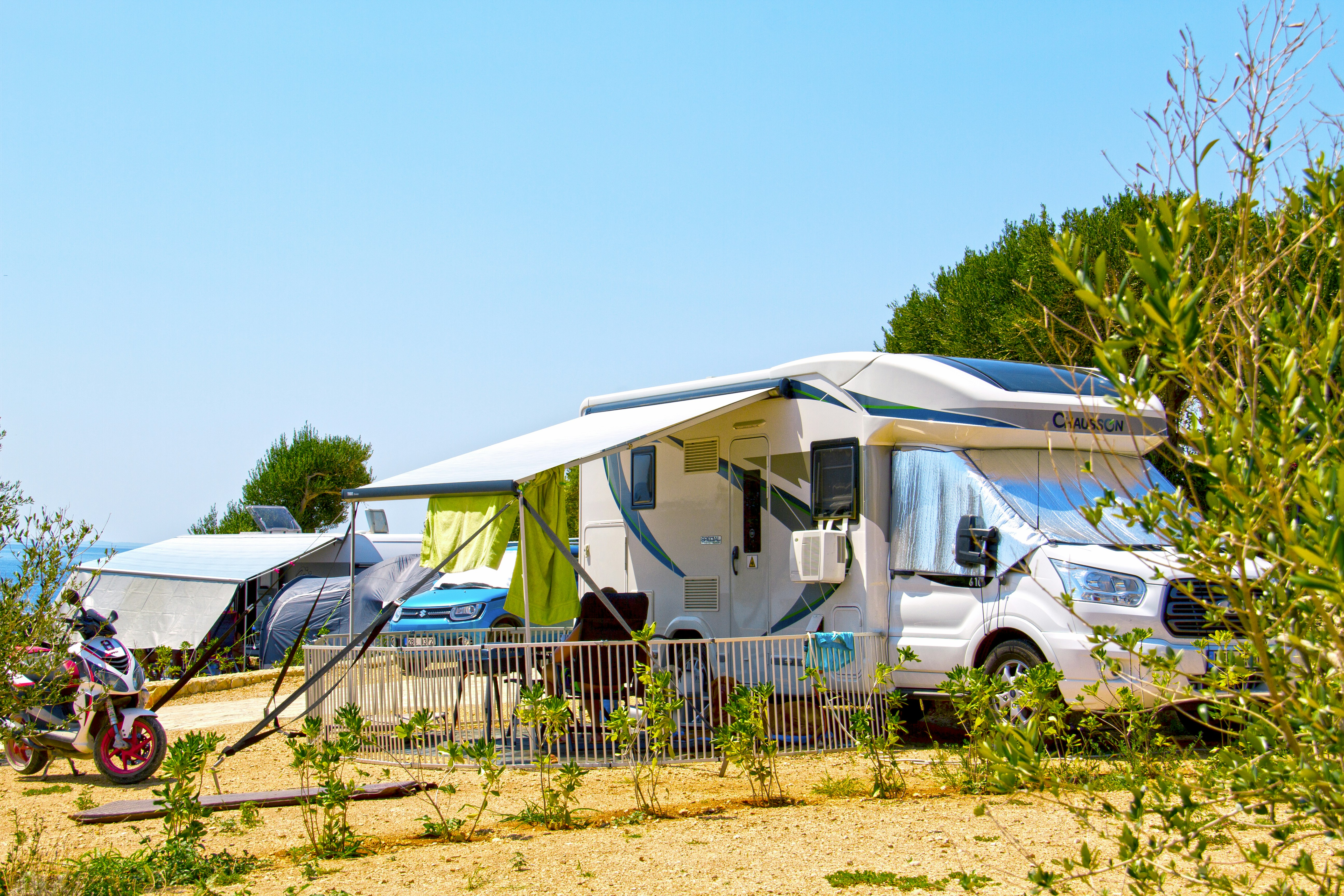 White and blue camper trailer on green grass field during daytime photo ...