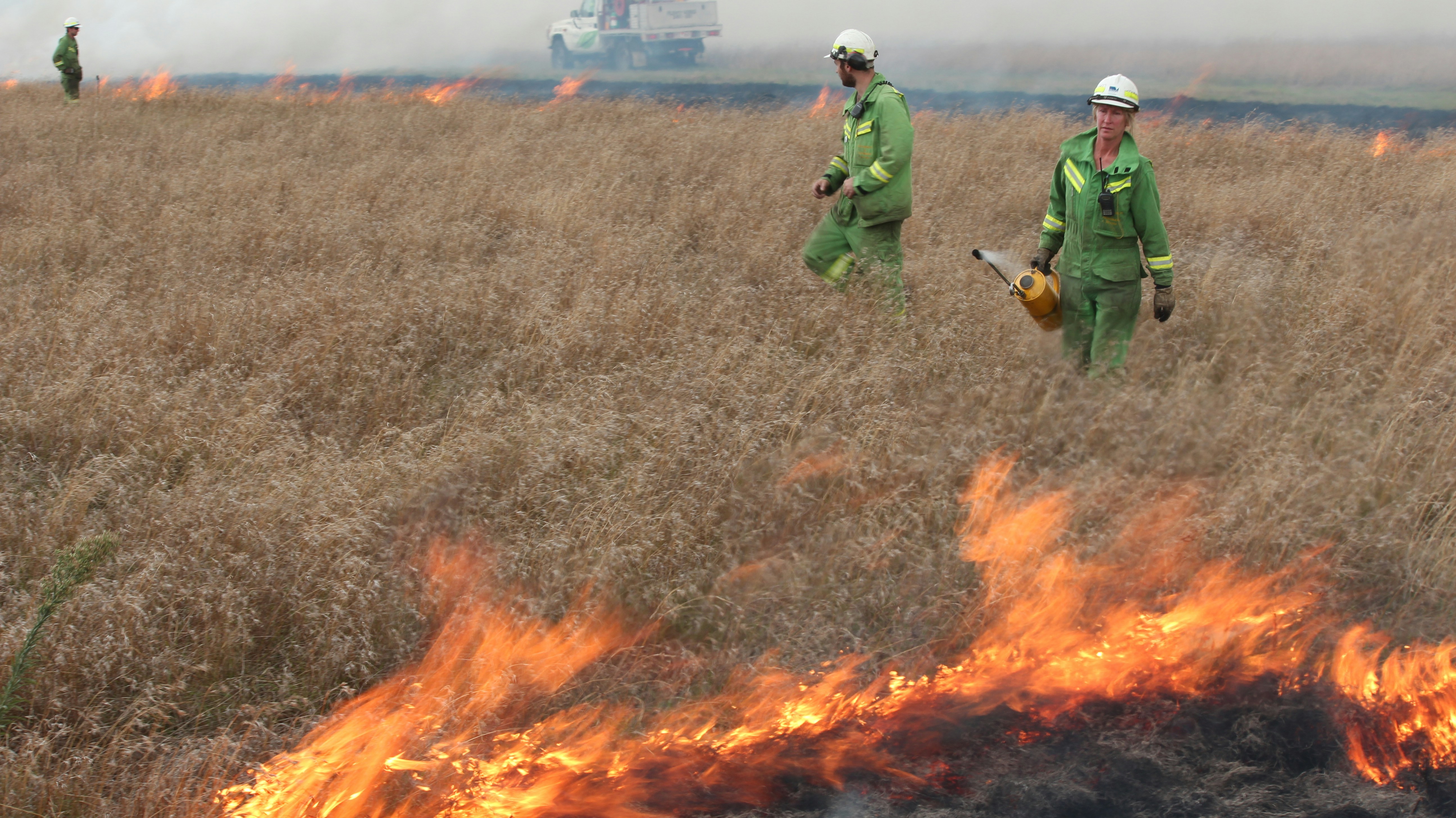 Crackling Field Embers: Firefighters Rally Across a Blaze-Swept Plain