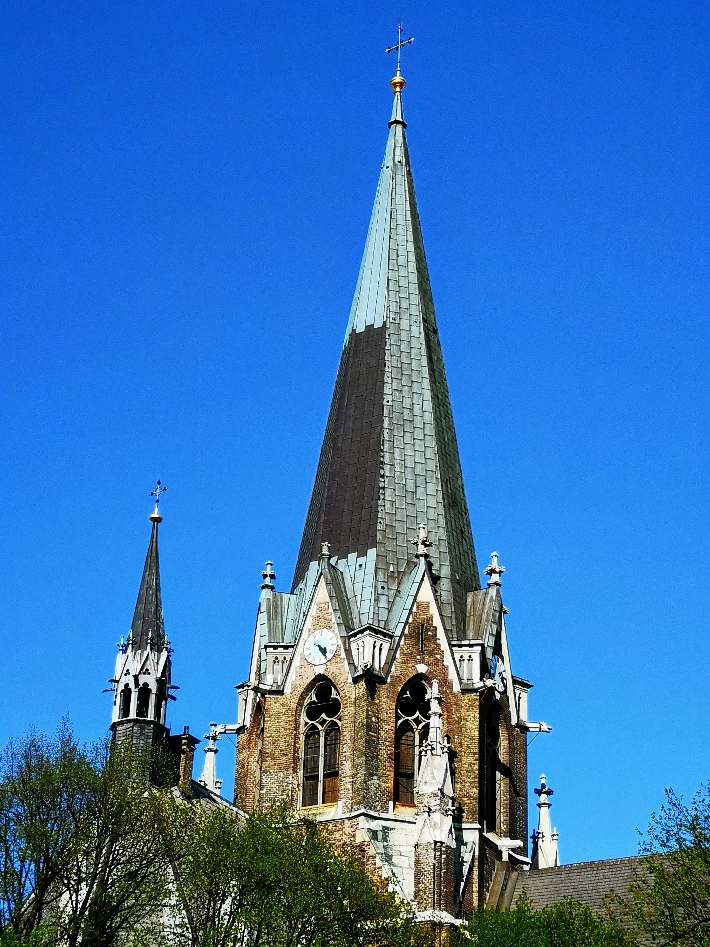 Brown and gray concrete church under blue sky during daytime photo ...