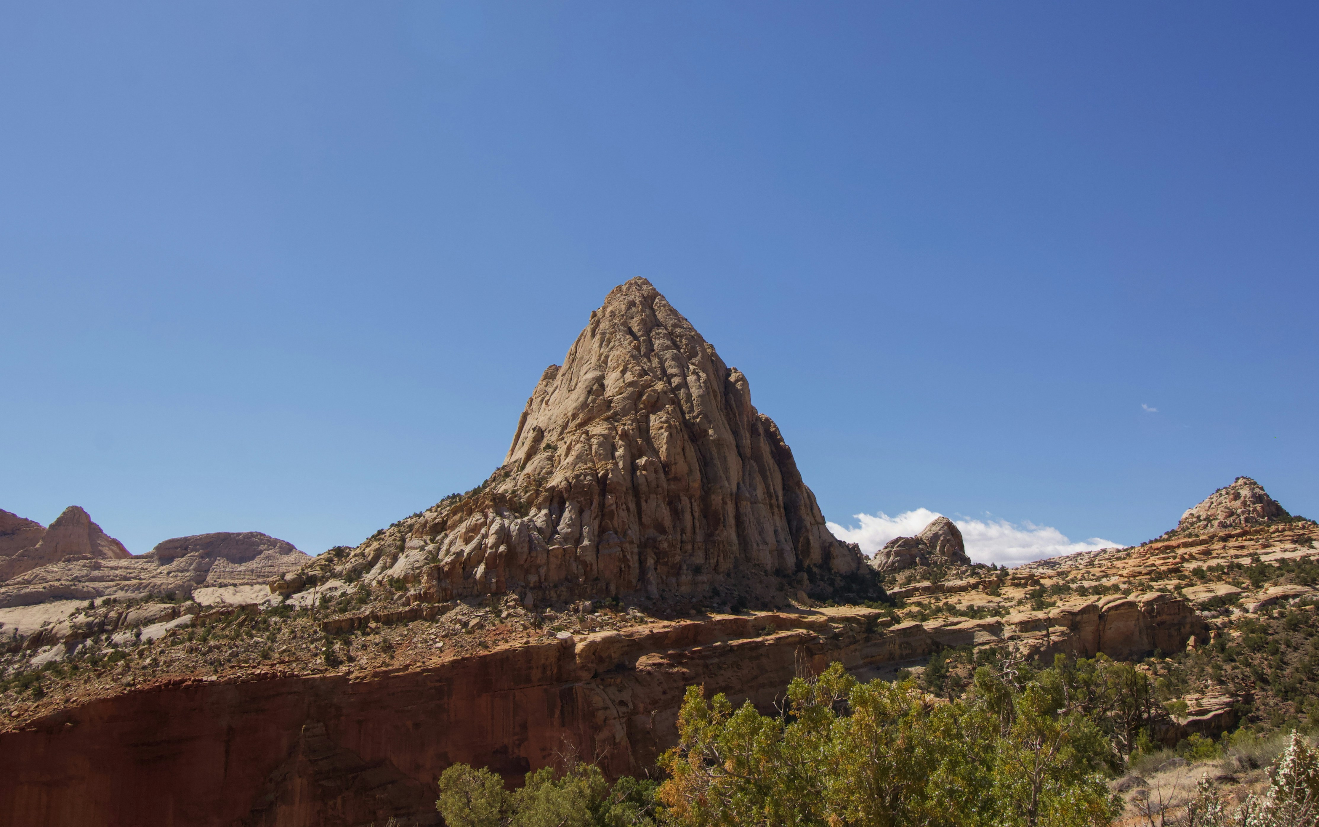 Granite Pinnacle Rising Over Desert Rim under a Clear Blue Sky