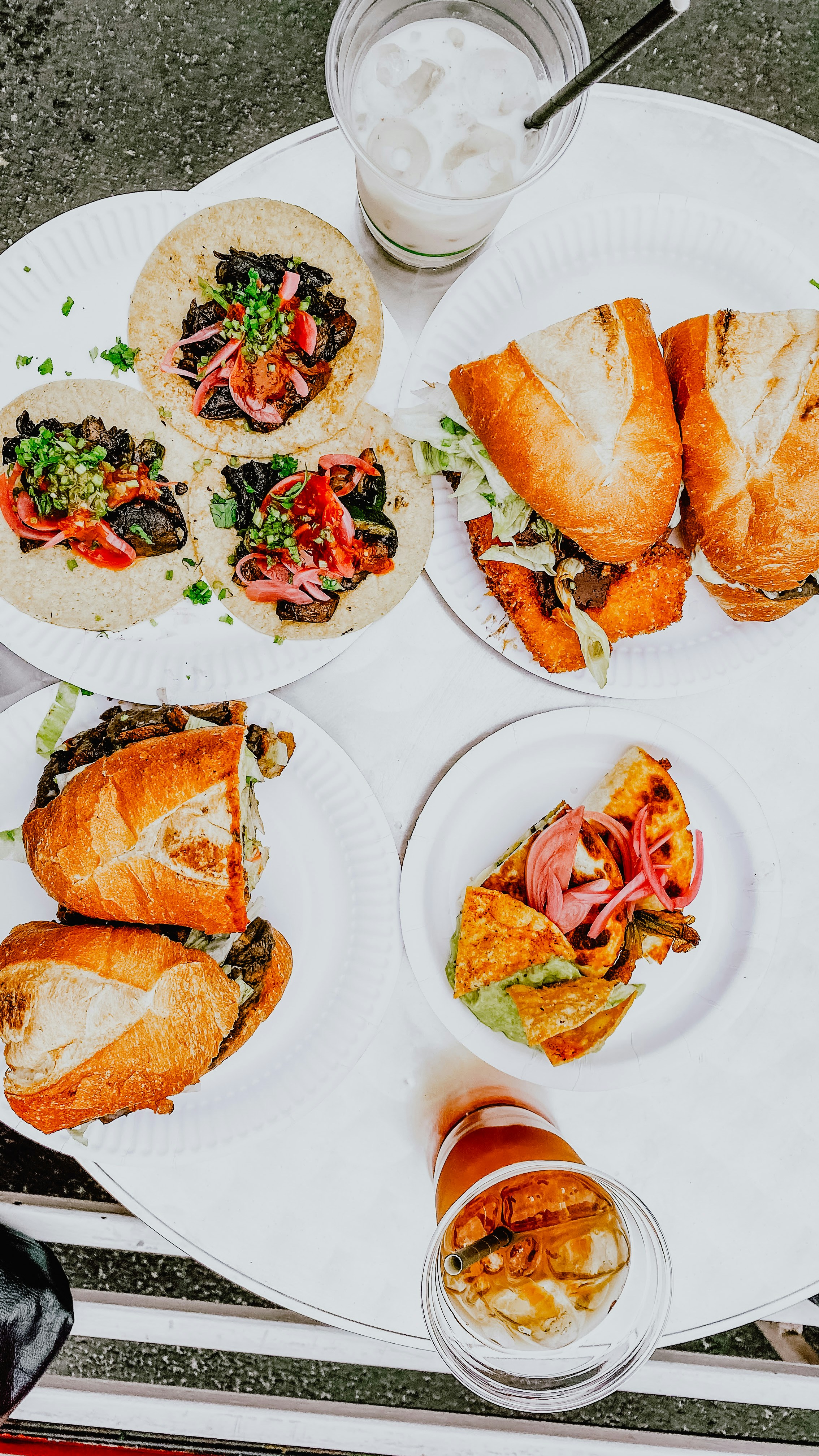Overhead Picnic: Tacos, Buns, and Glasses on a Round Table