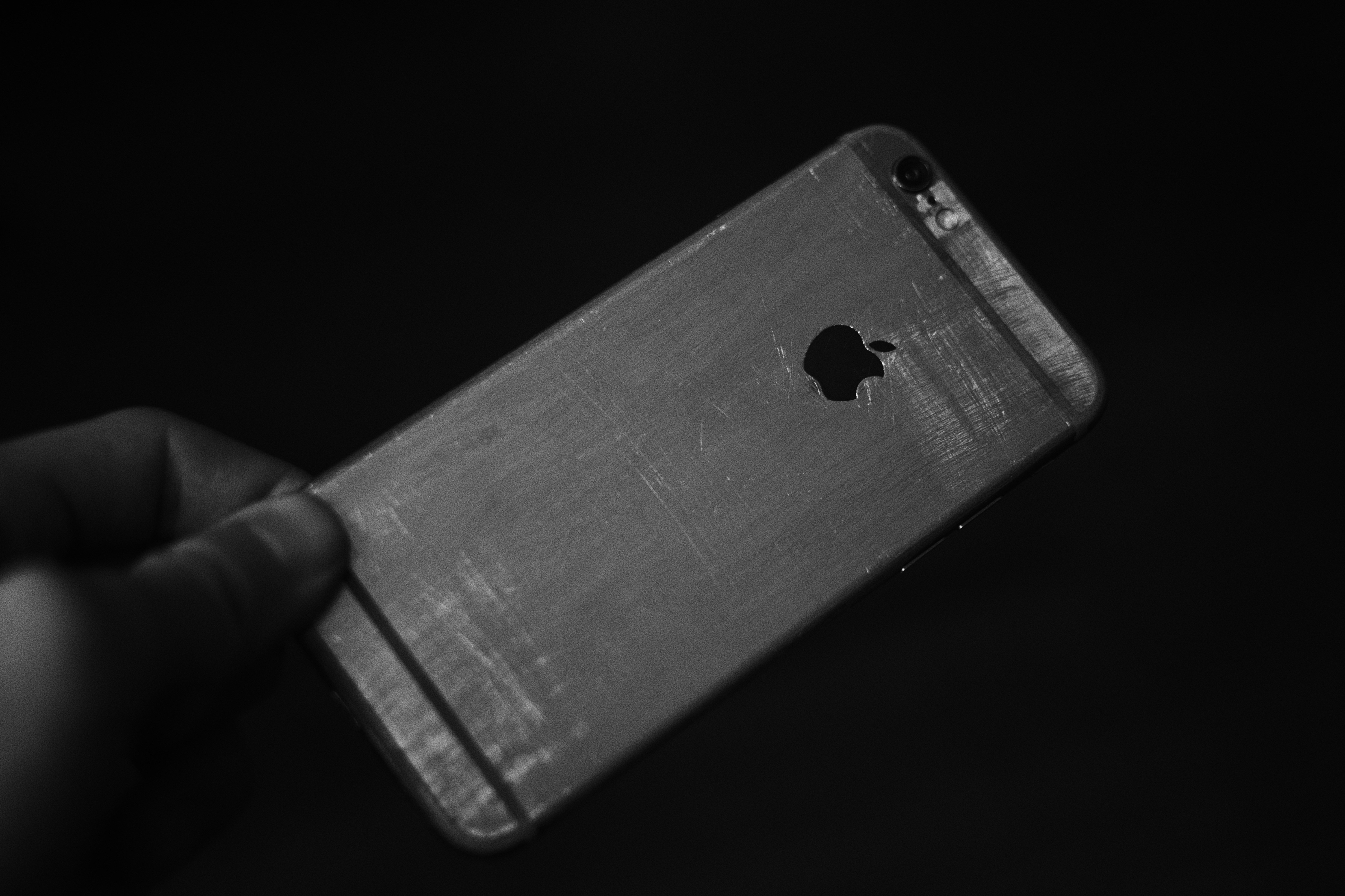 Scratched and weathered back of a smartphone highlighting its journey through use and time.