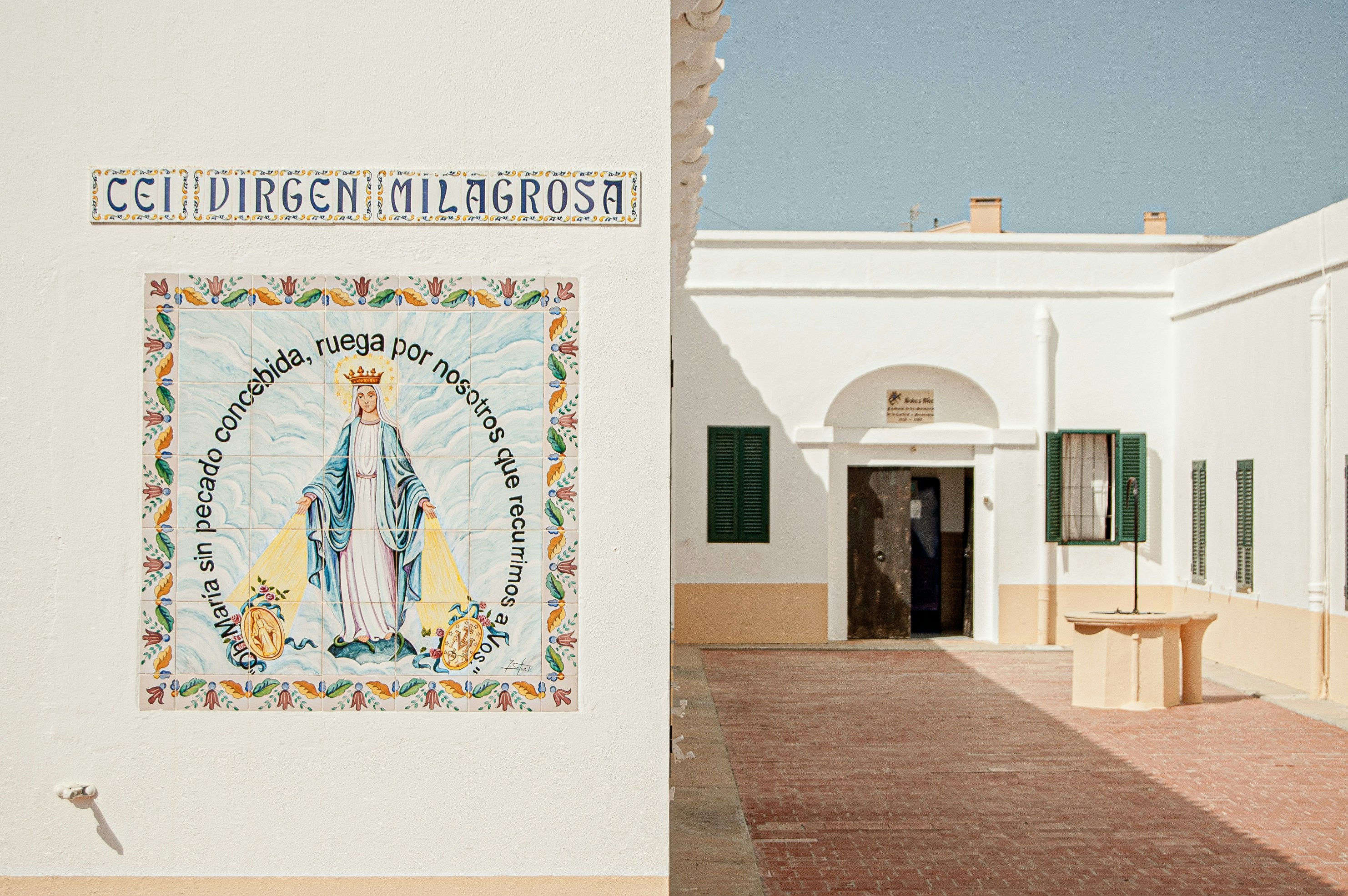 Sunlit Courtyard Portrait: A Shrine of White Walls and Painted Tile