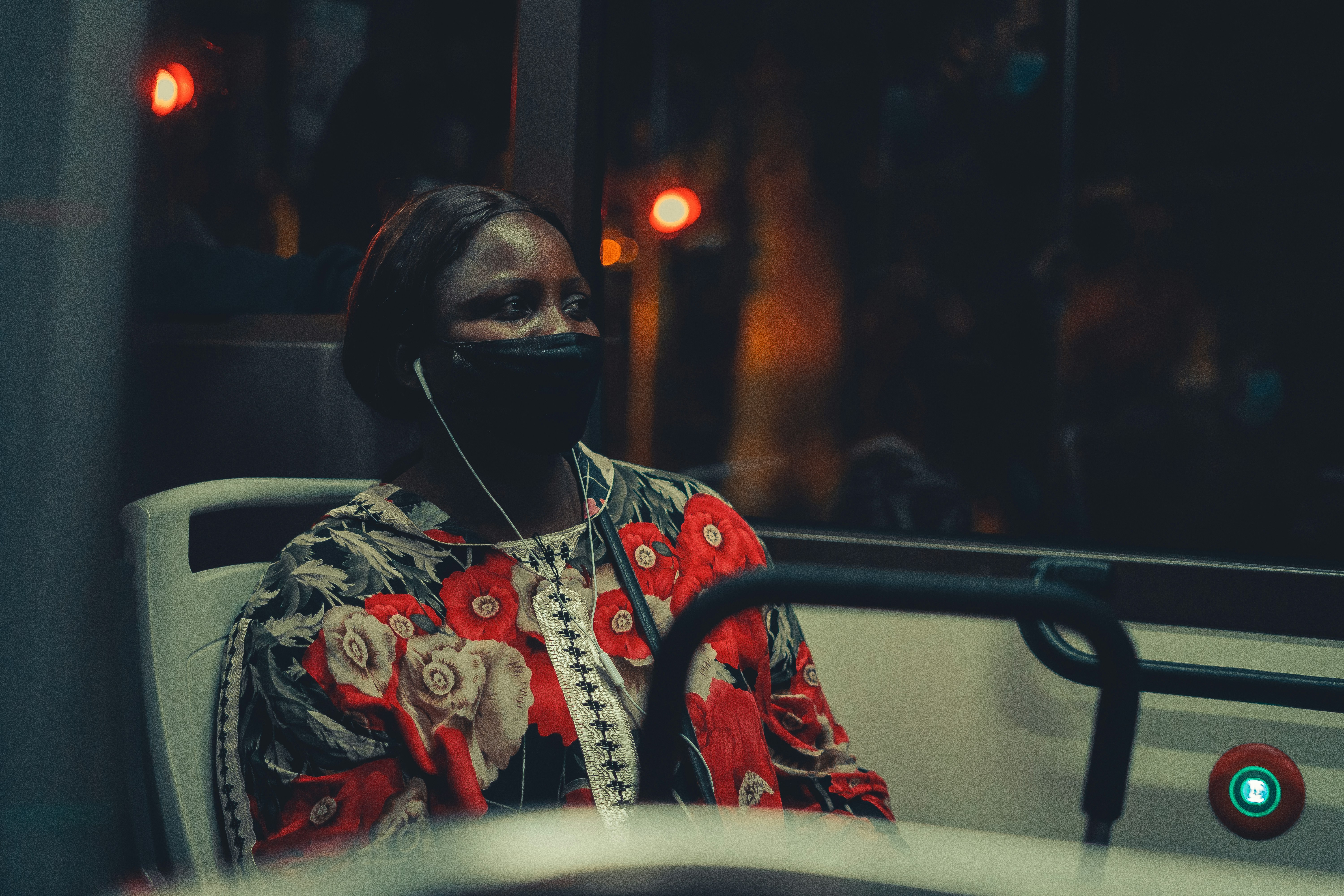 Midnight Commute: A Masked Moment in a Red Floral Coat