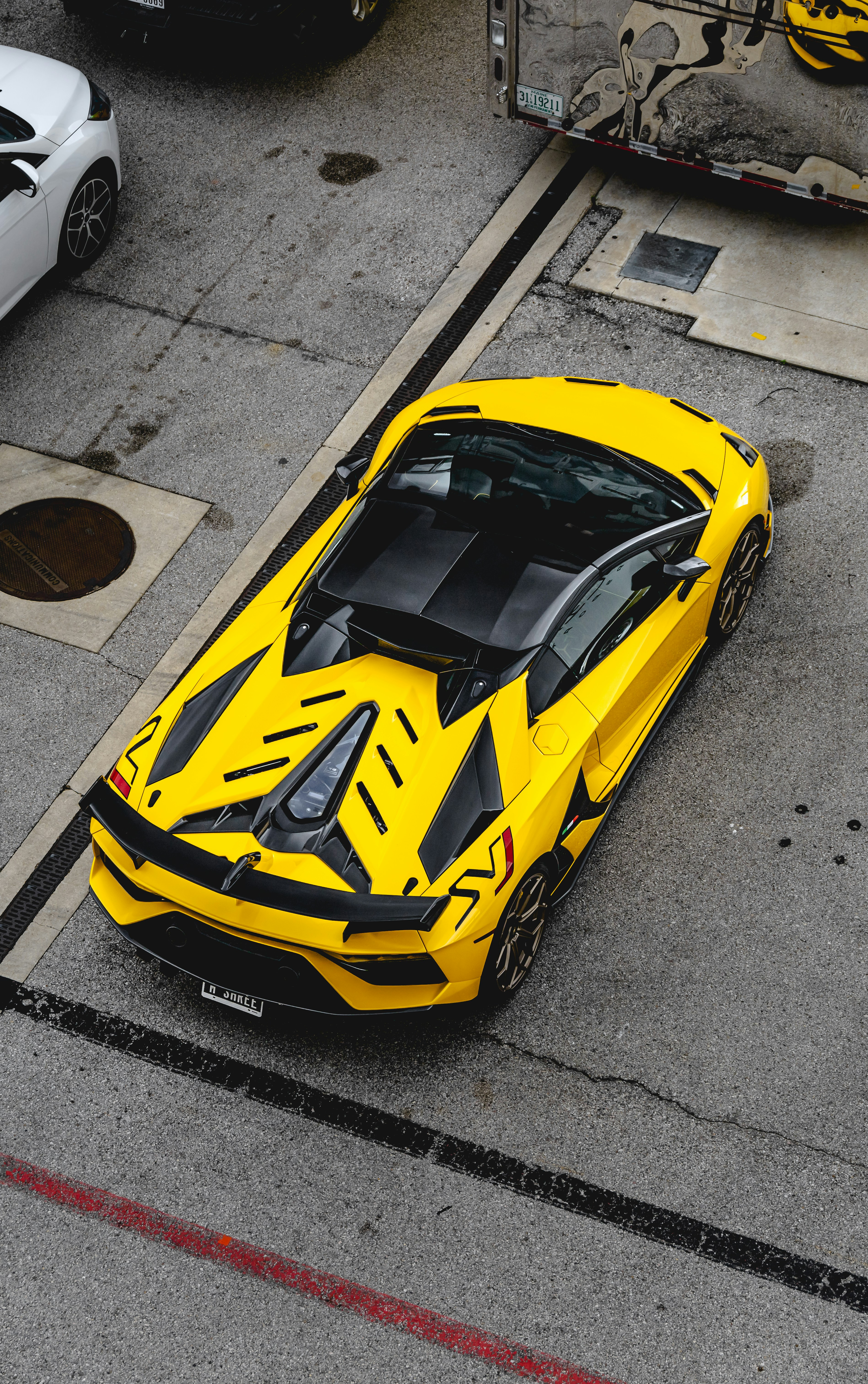 Yellow lamborghini aventador parked on gray concrete road during ...