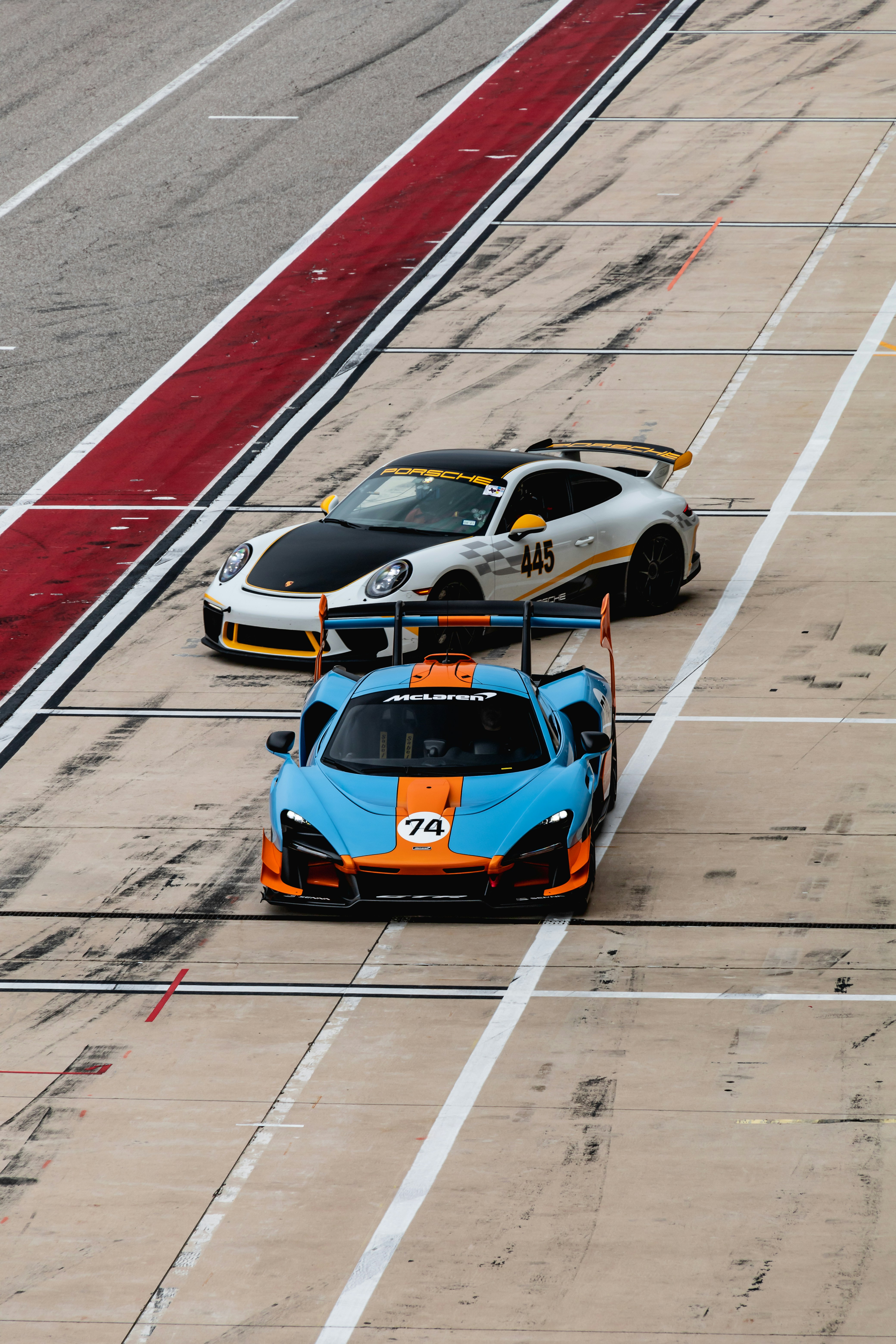 Two race cars driving on a race track photo – Free Usa Image on Unsplash