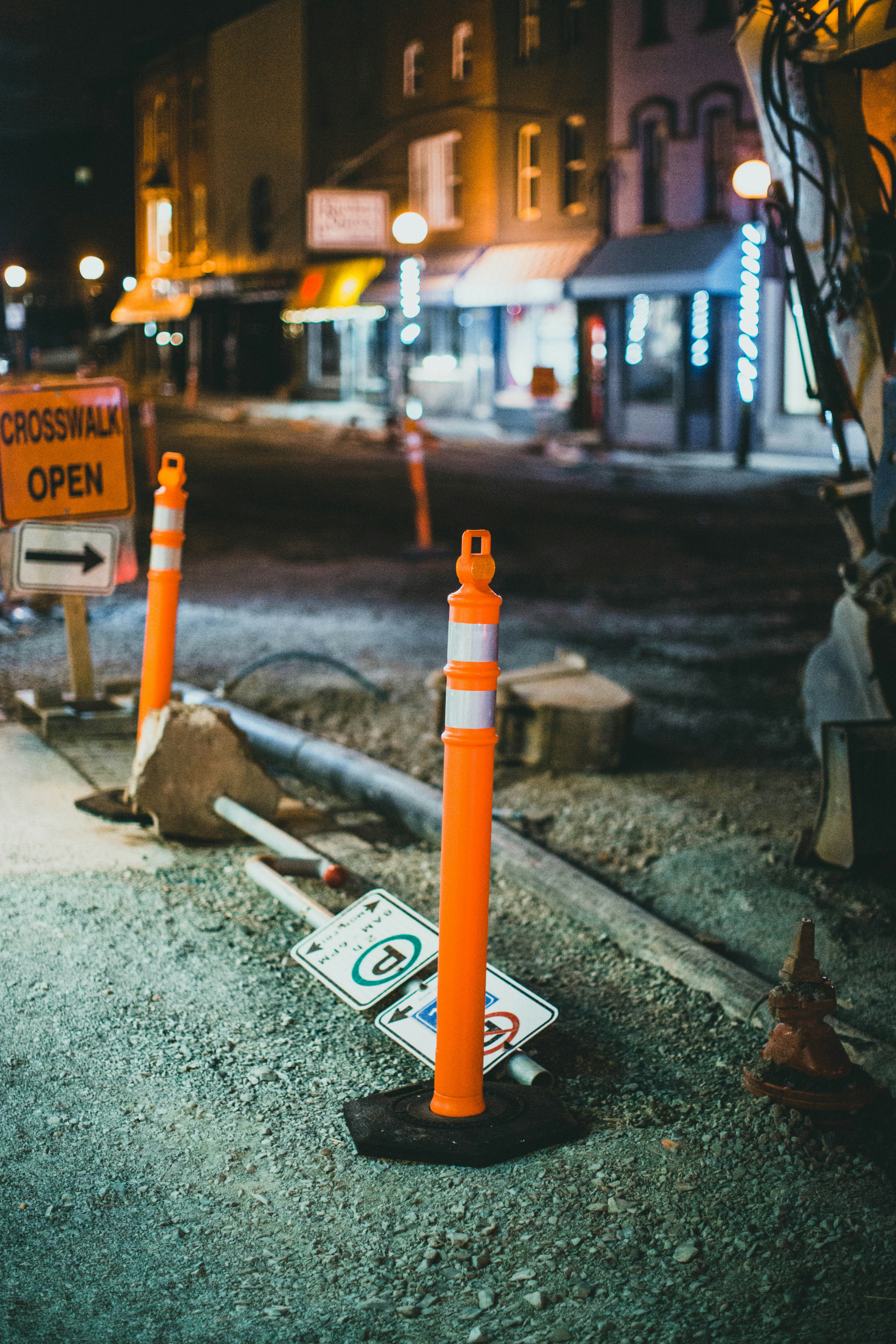 Midnight Work Zone: Neon Glow, Orange Cones, and a Fallen Sign