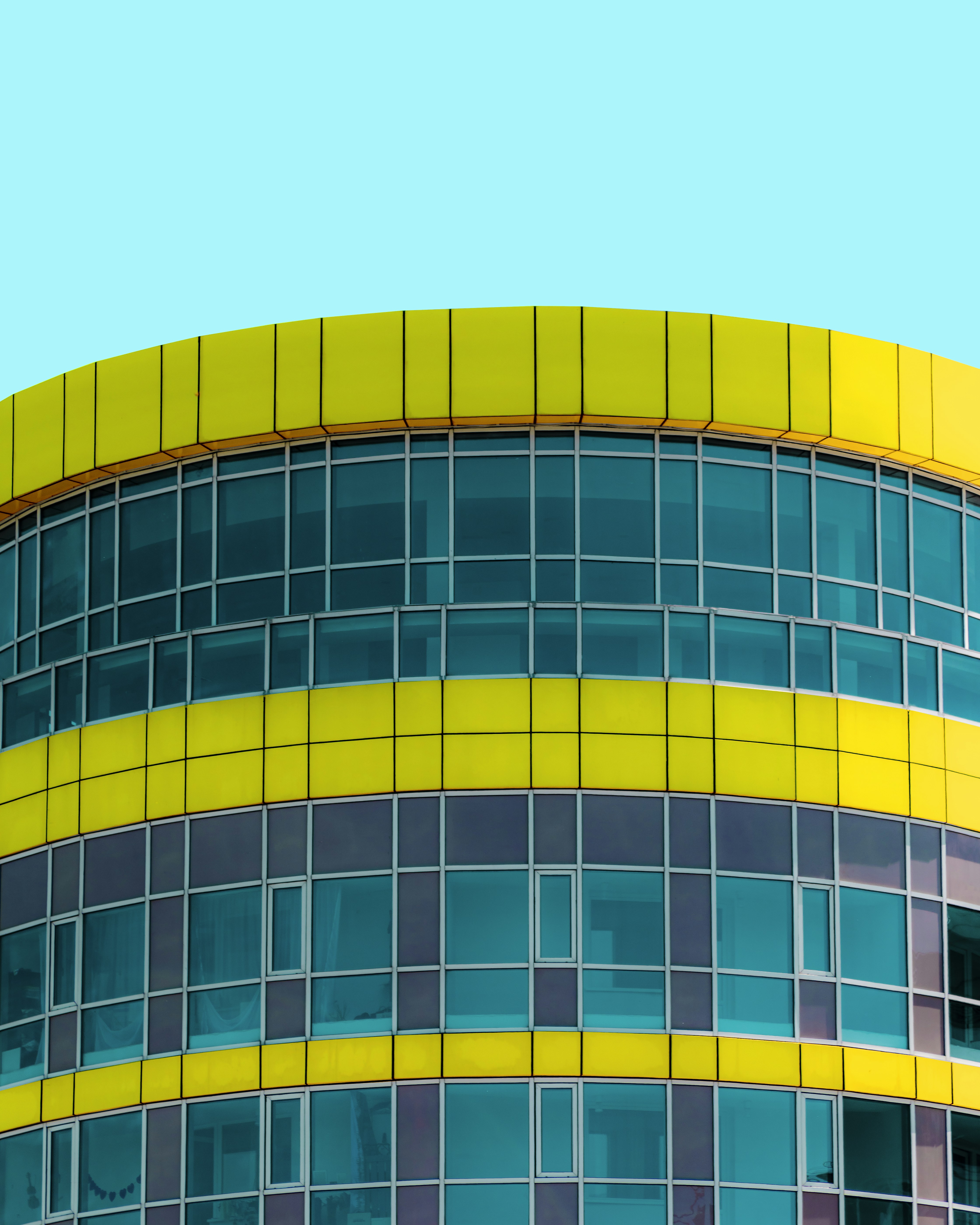 Rings of Glass and Yellow: A Curved Facade Reaches for the Sky