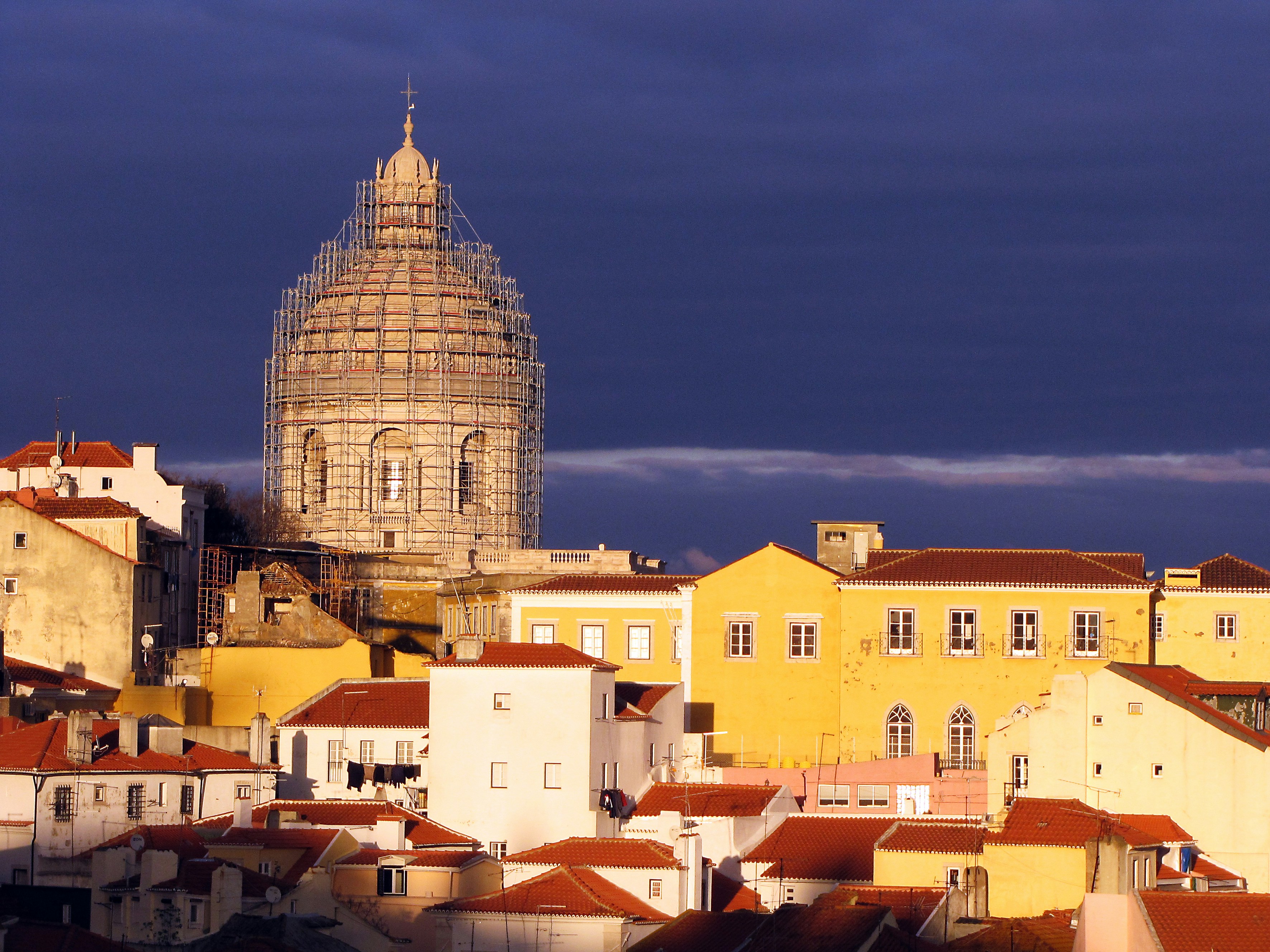 Dome in Scaffolding Over a Sun-Washed City of Tiles