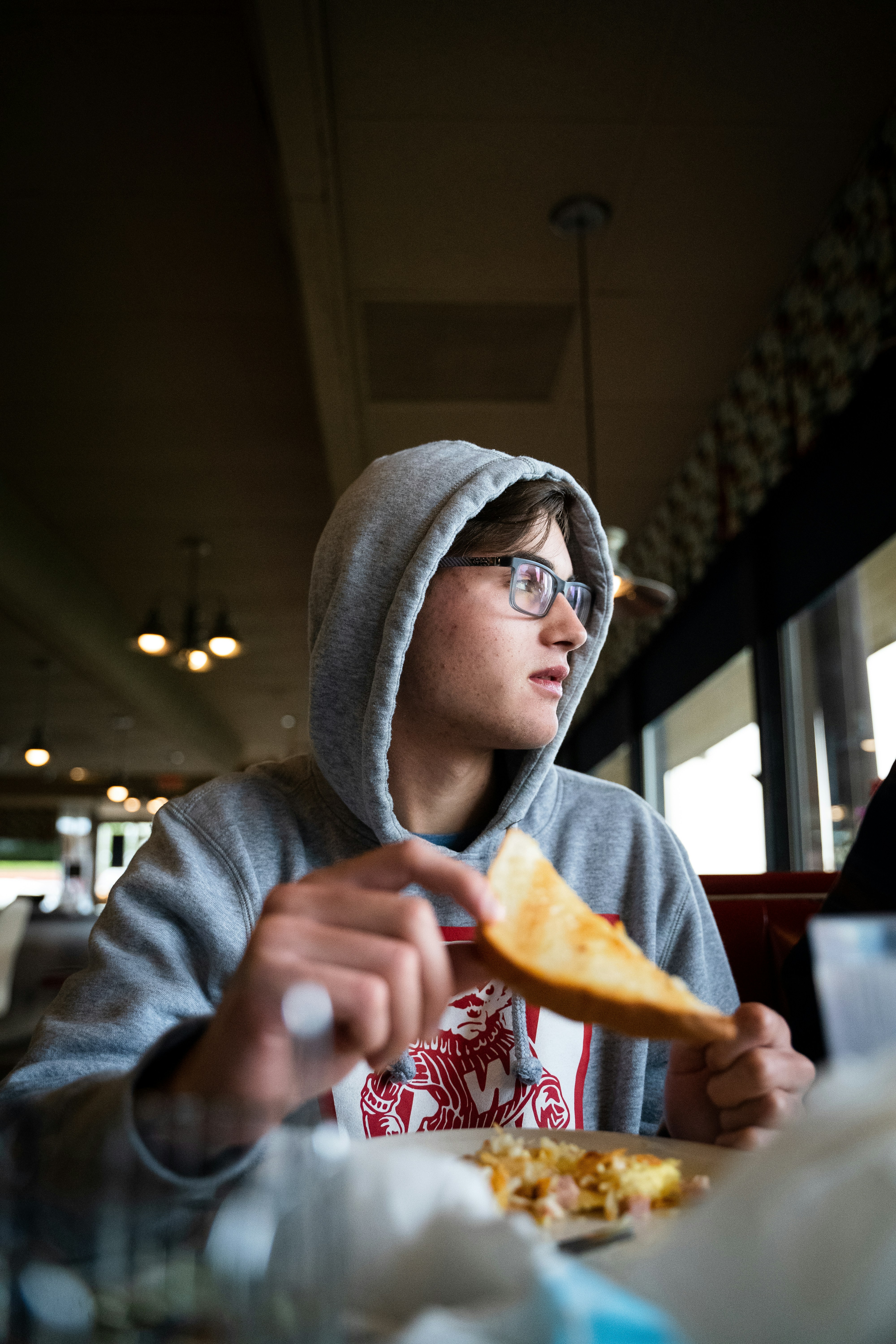 Person in gray hoodie holding bread photo – Free Food Image on Unsplash
